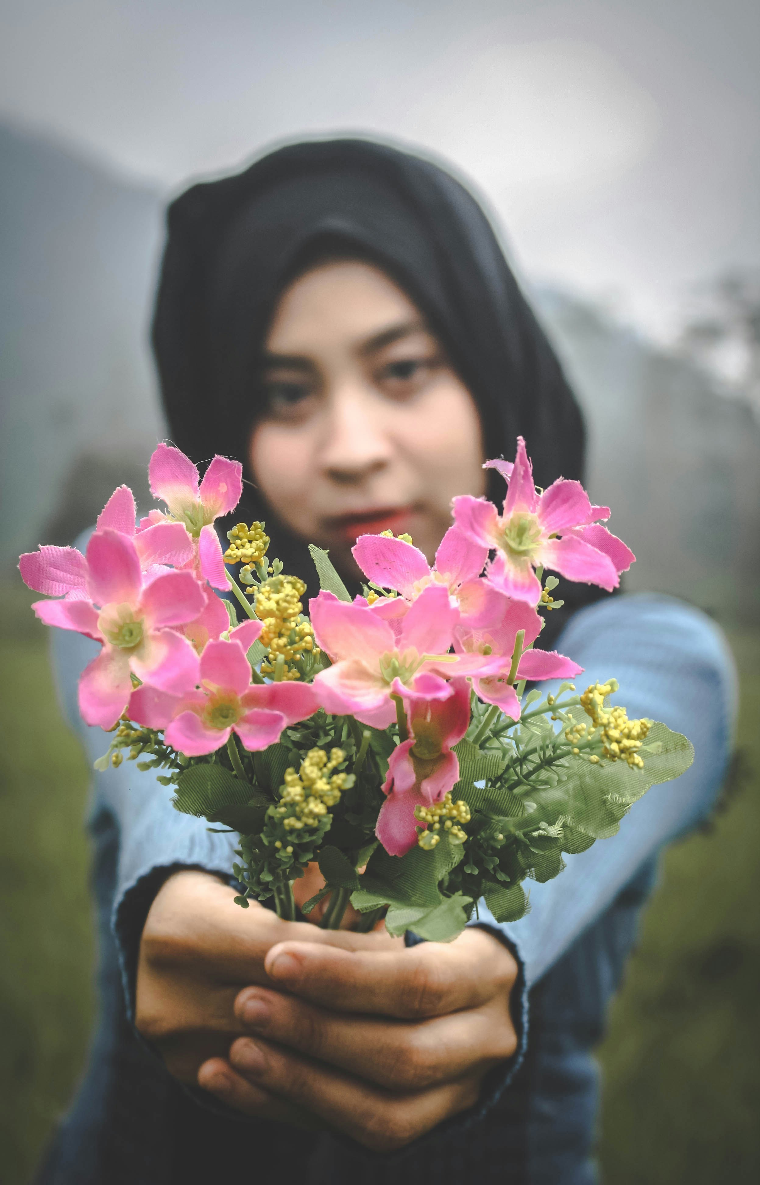 Petals on Offer: A Soft-Focus Portrait of a Quiet Gift