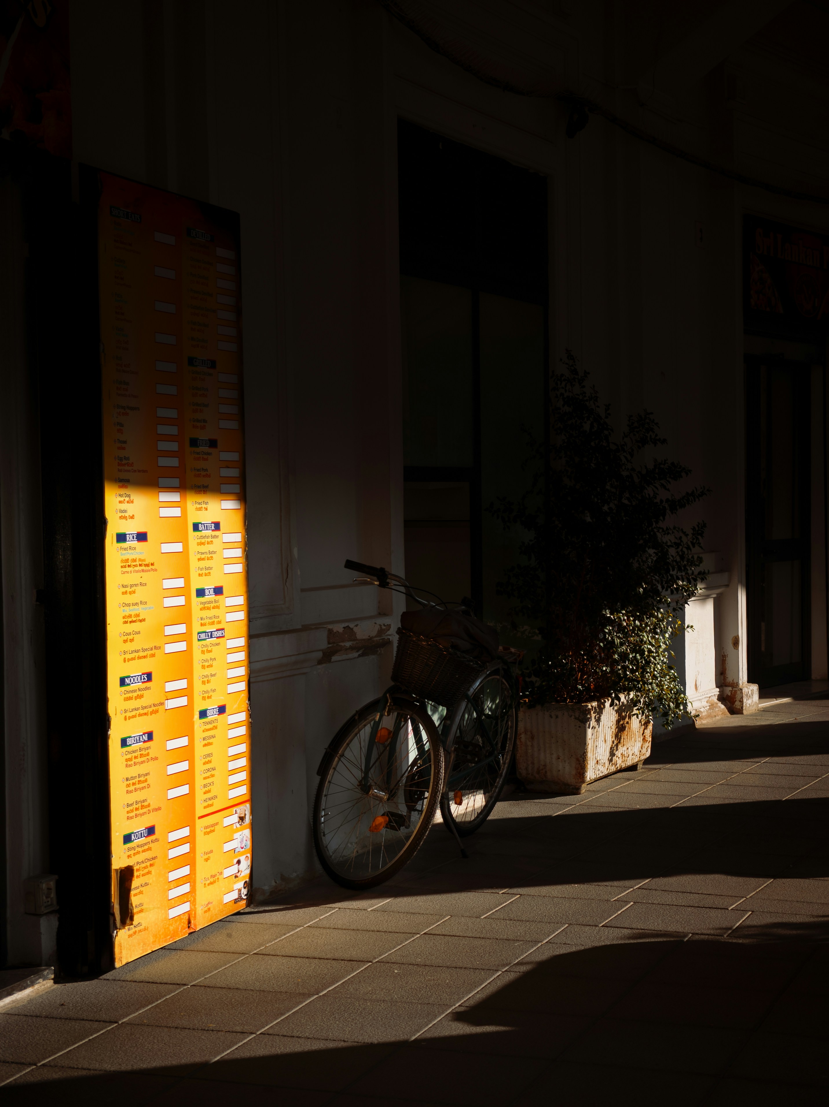 A bike parked on the side of a building