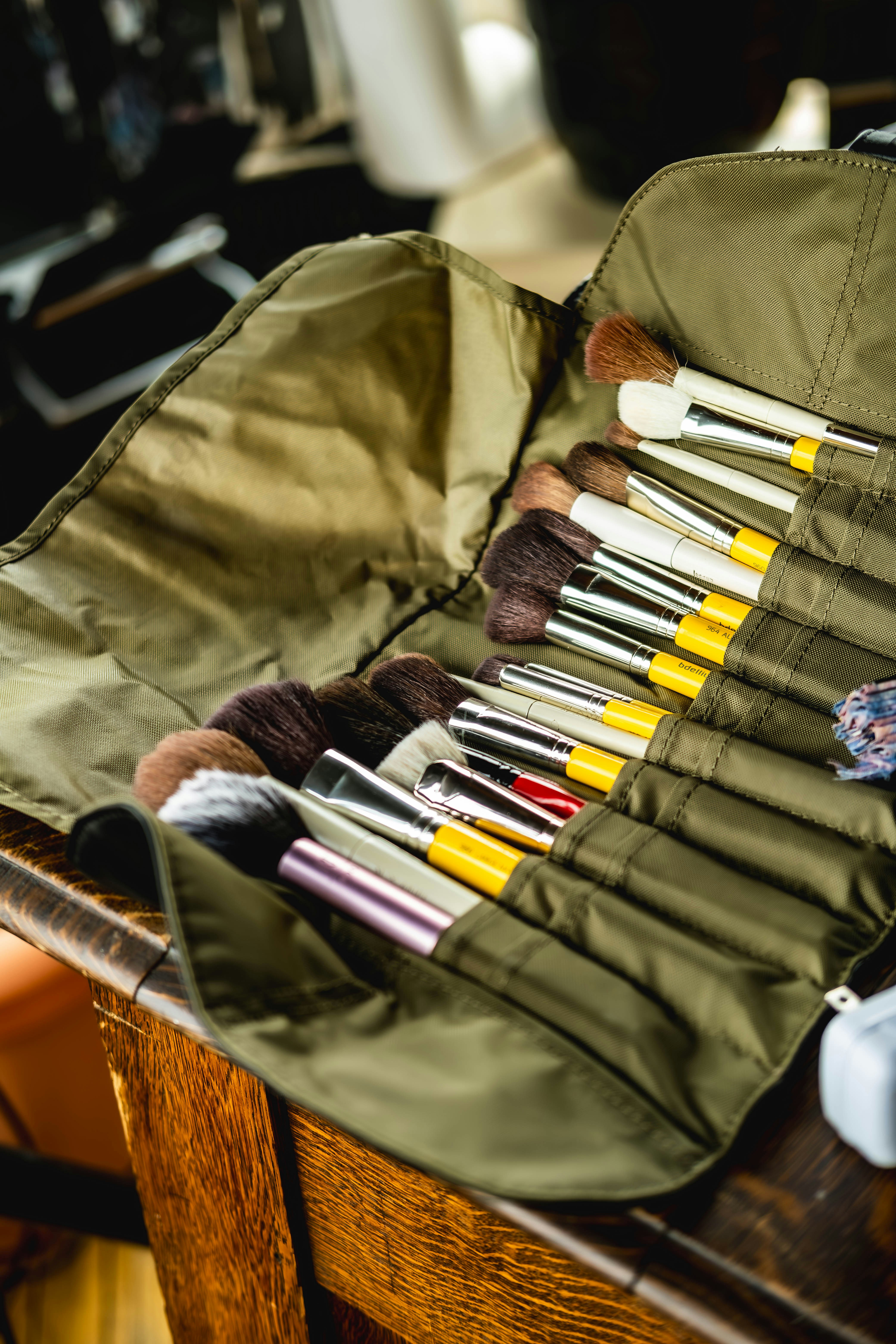 Row of Golden-Handled Brushes Unfolded Across a Wooden Table