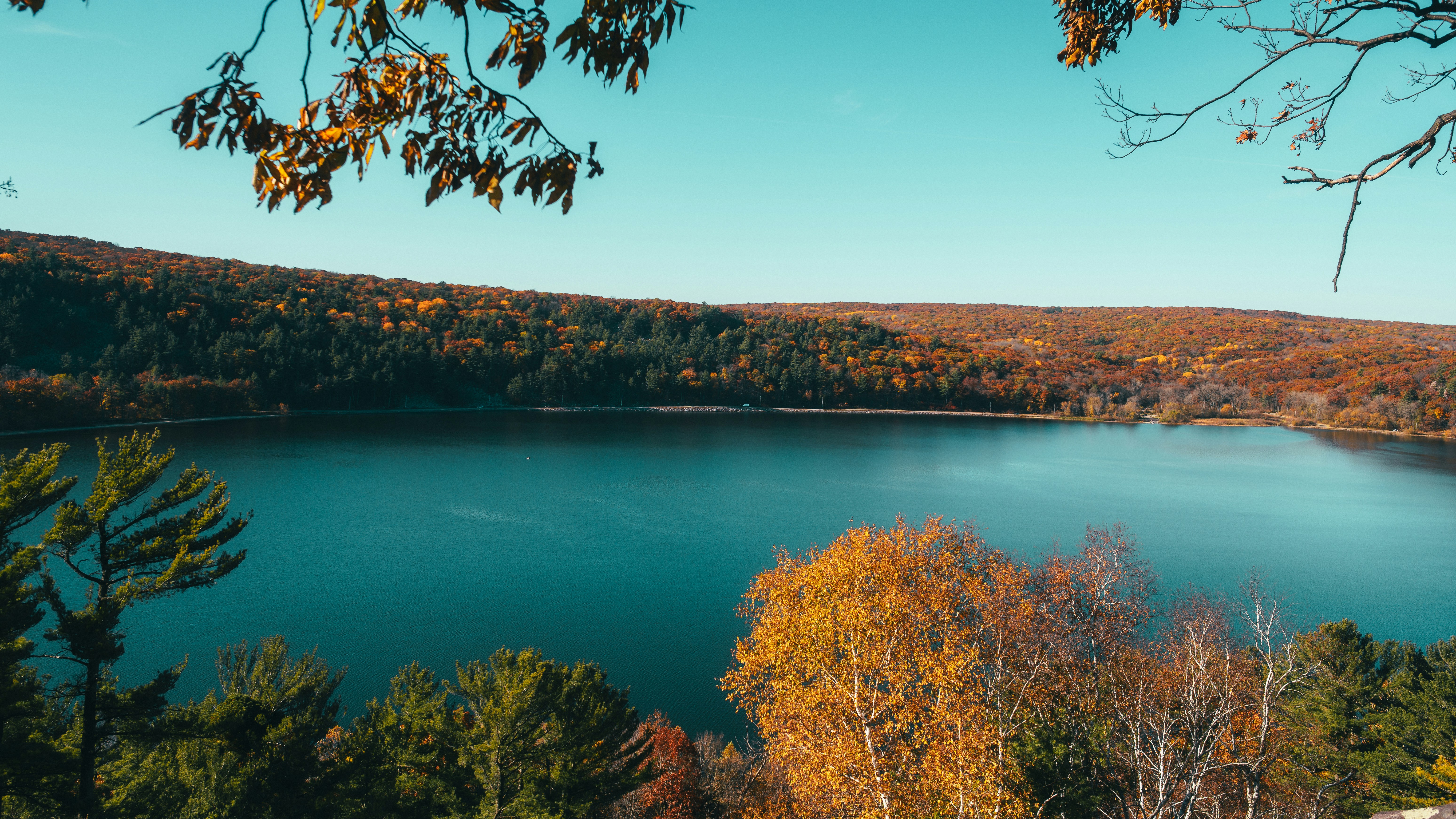 A lake surrounded by trees in the fall photo – Free Devils lake Image ...