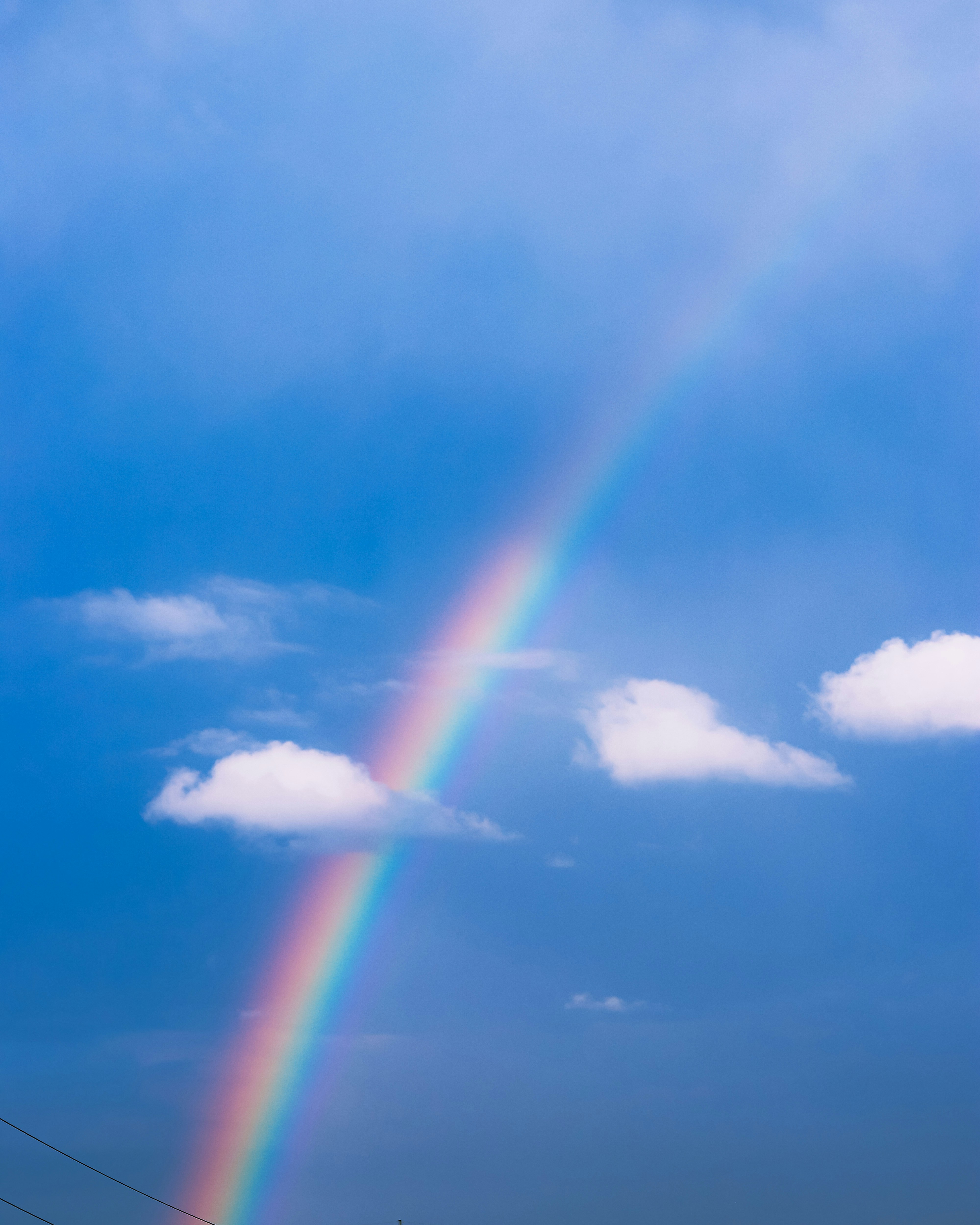 A rainbow in a blue sky with clouds photo – Free Rainbow Image on Unsplash