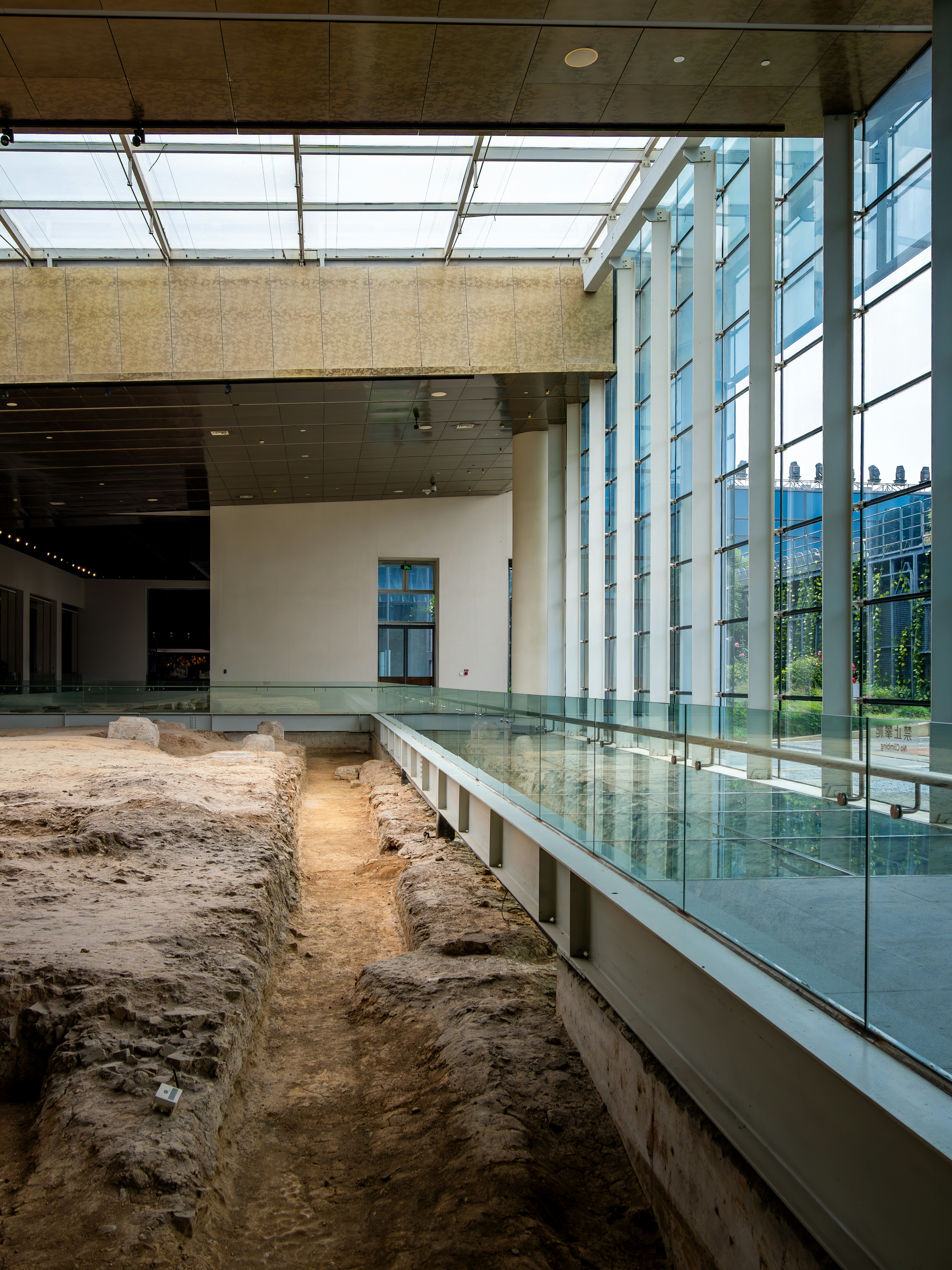 Echoes Under Glass: A Modern Hallway Framing an Ancient Trench