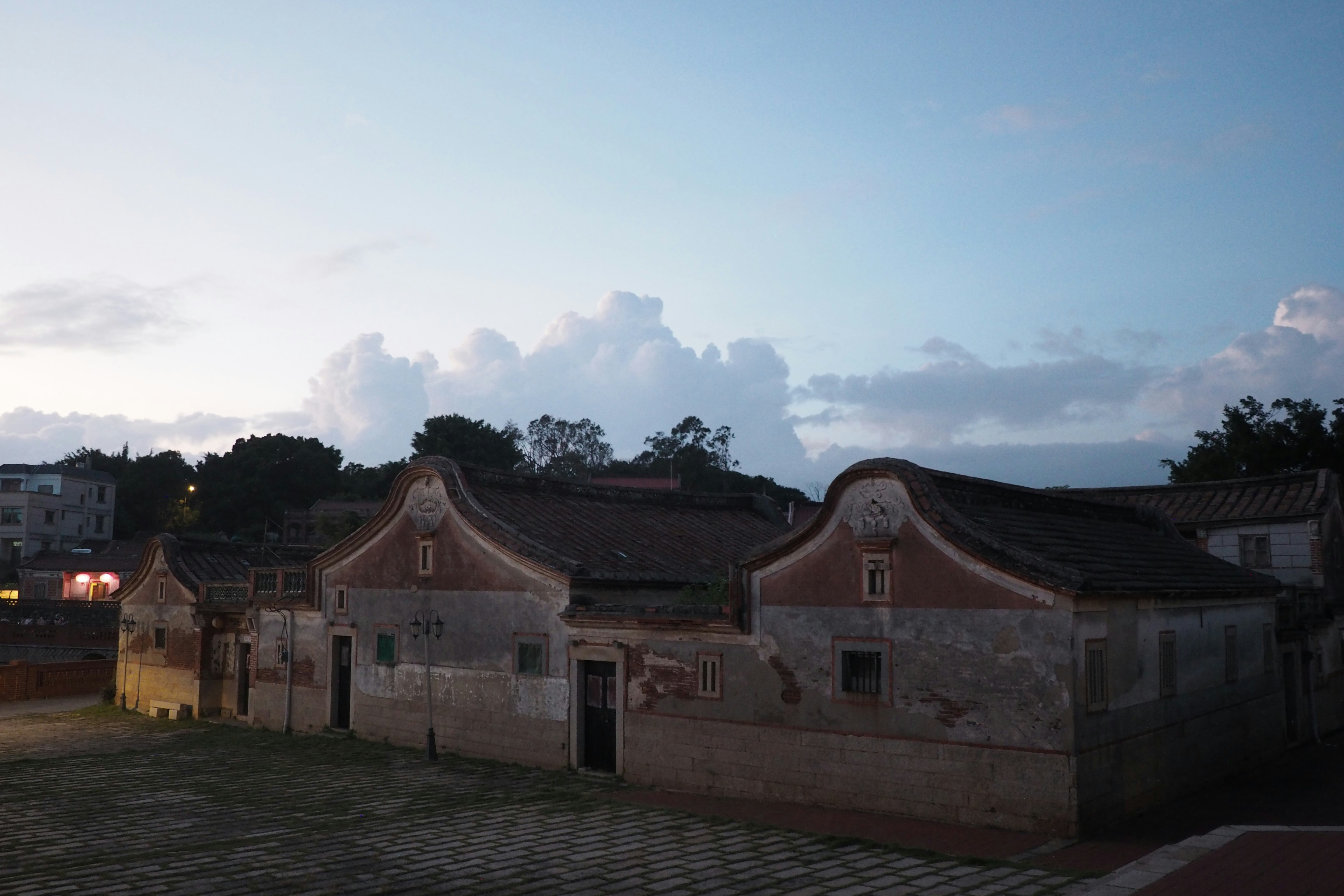 Gabled Echoes at Dusk: A Quiet Row of Brick Courtyards