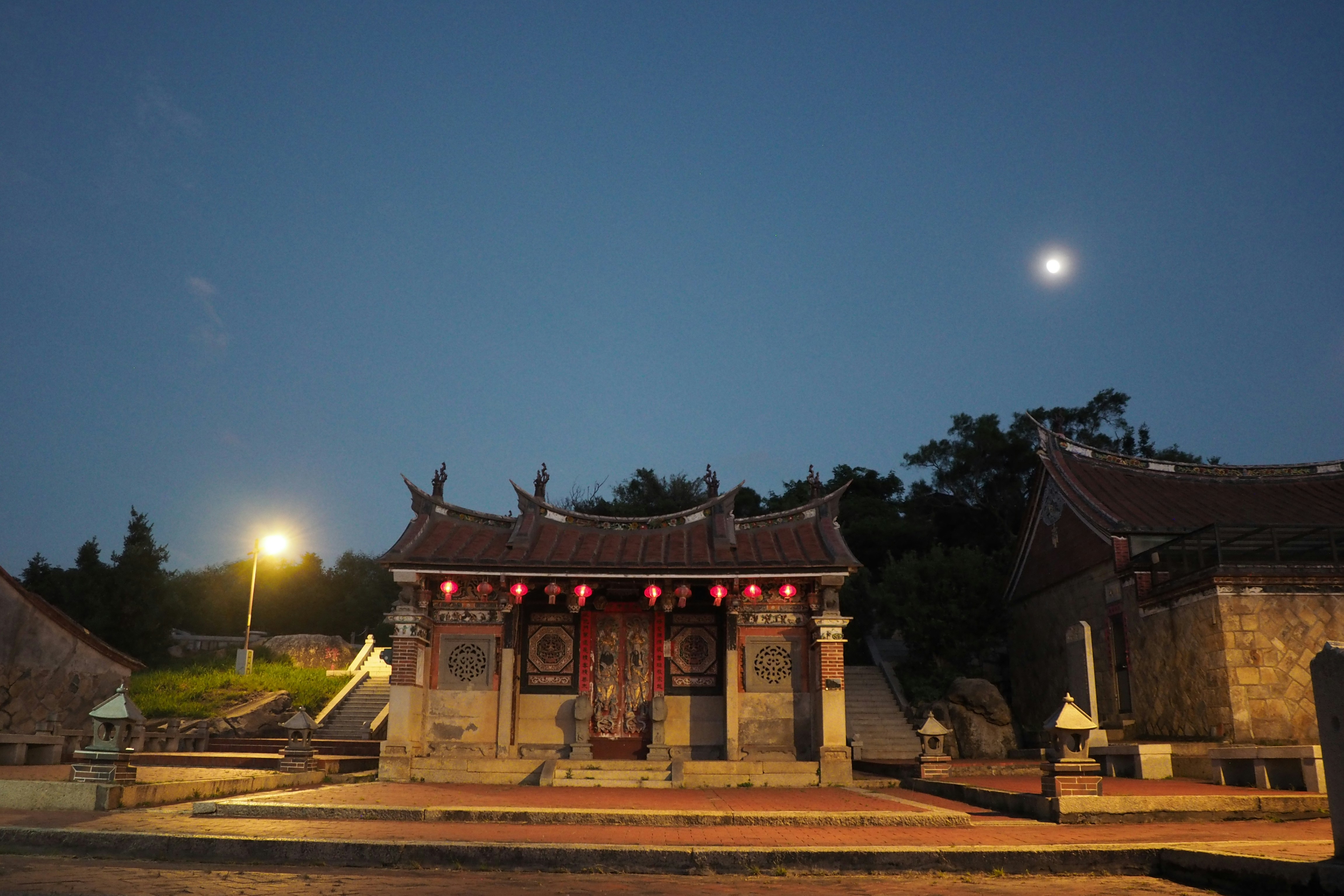 Lantern-Lit Temple Courtyard Under a Crescent Moon