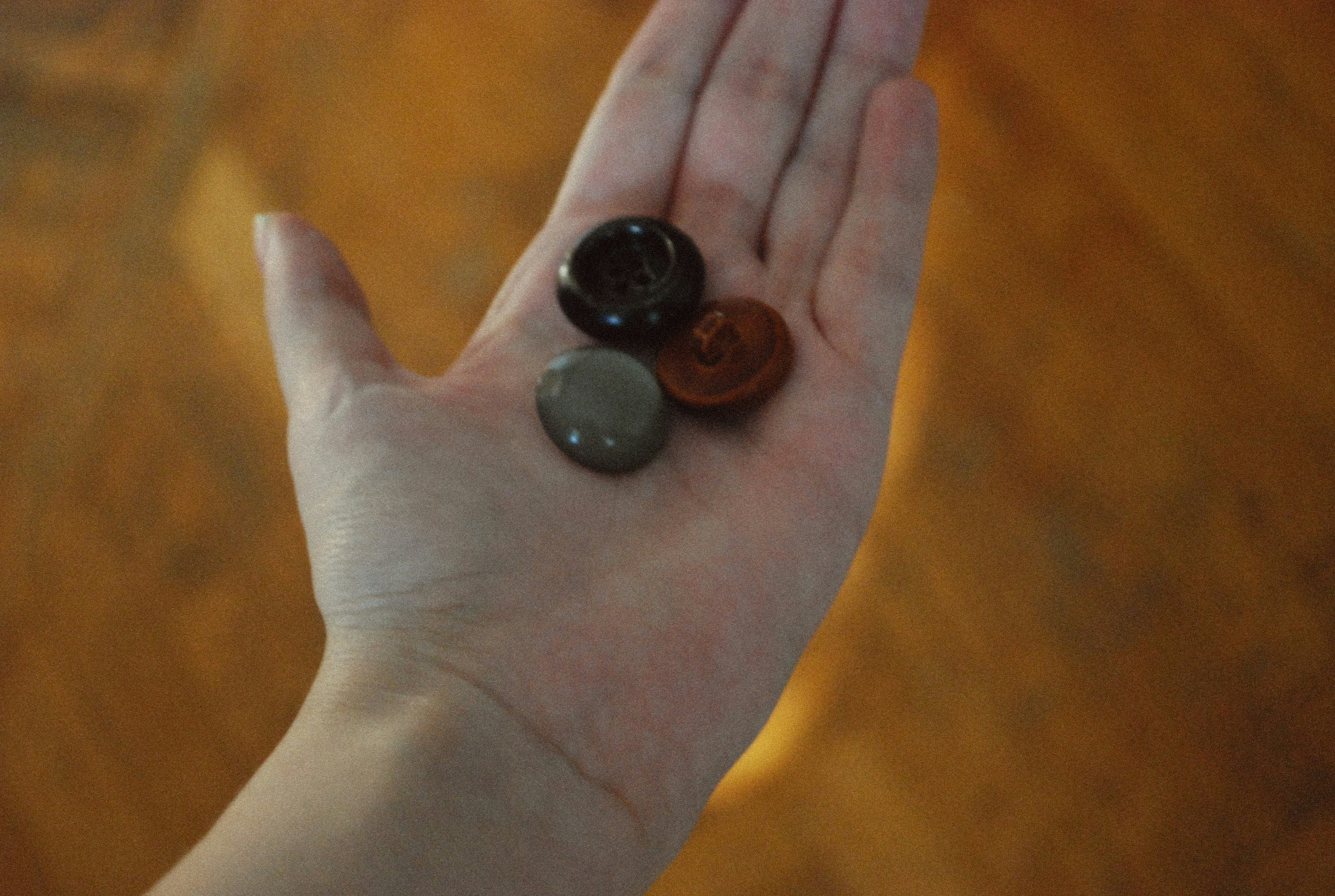 A person's hand holding two buttons in the palm of their hand photo ...