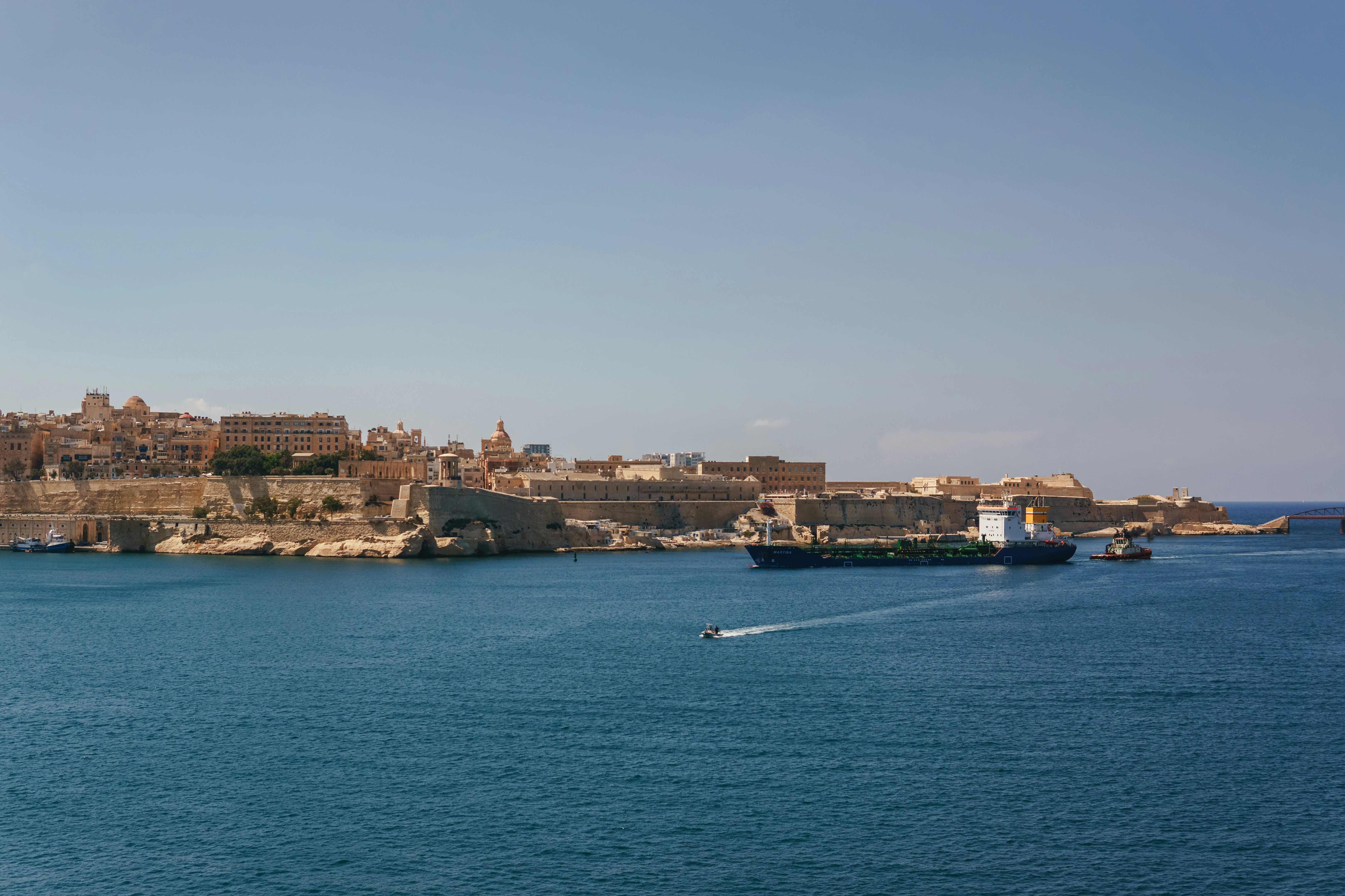 A large body of water with a city in the background photo – Free Malta ...