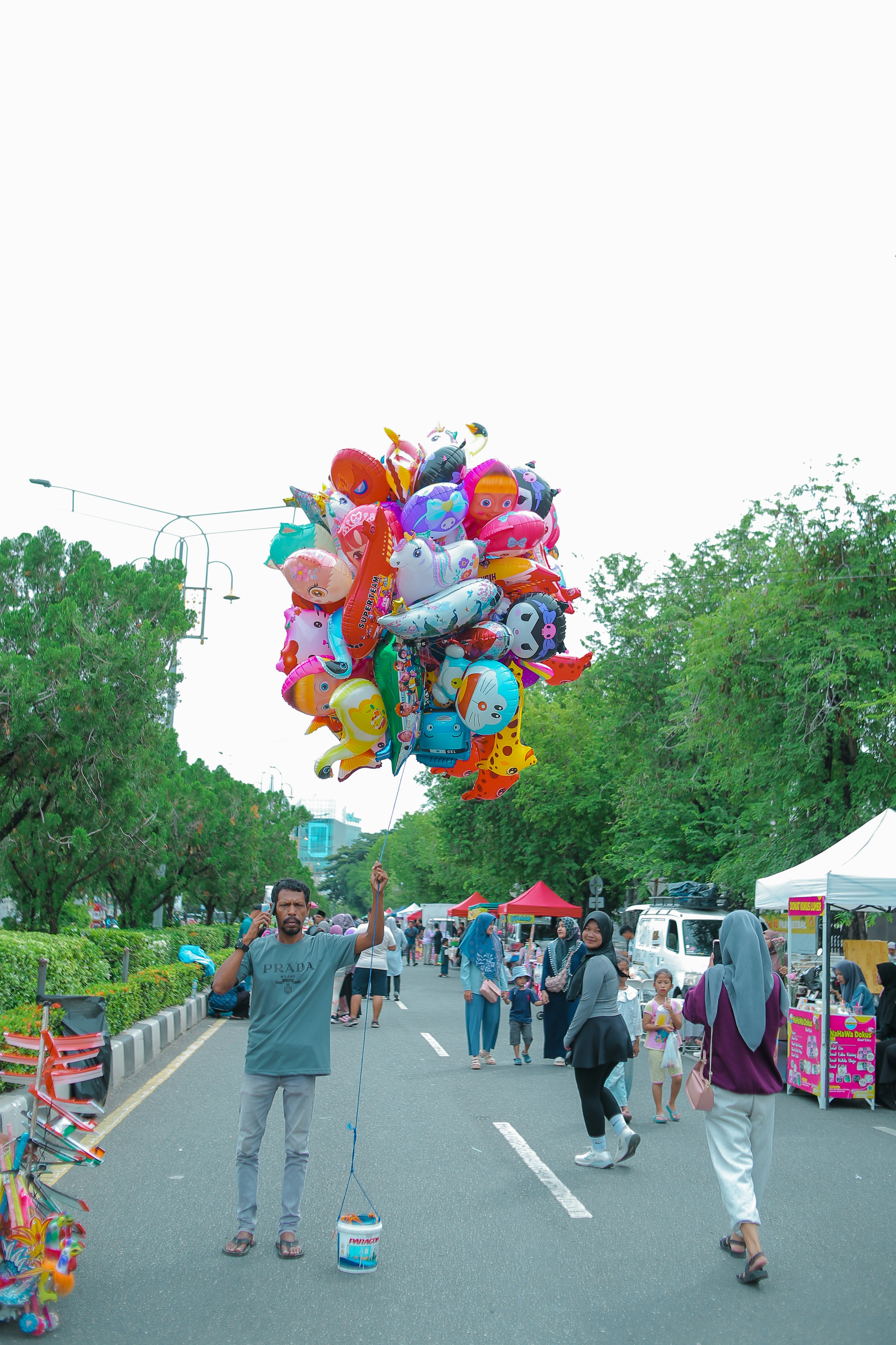 Balloon Cascade Over a Busy Street Market