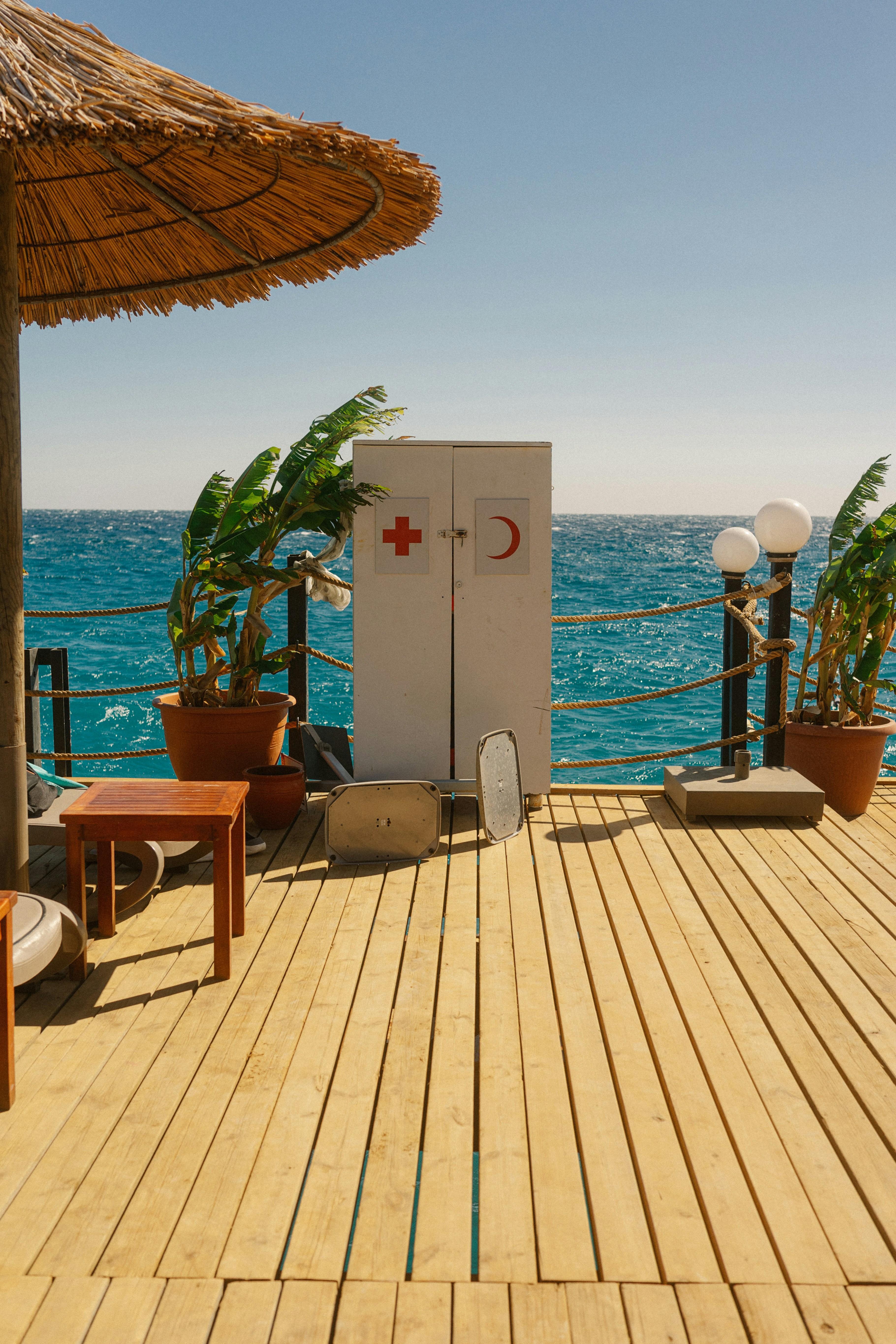 Sunlit Seaside Standby: A White Medical Cabinet Framing the Horizon