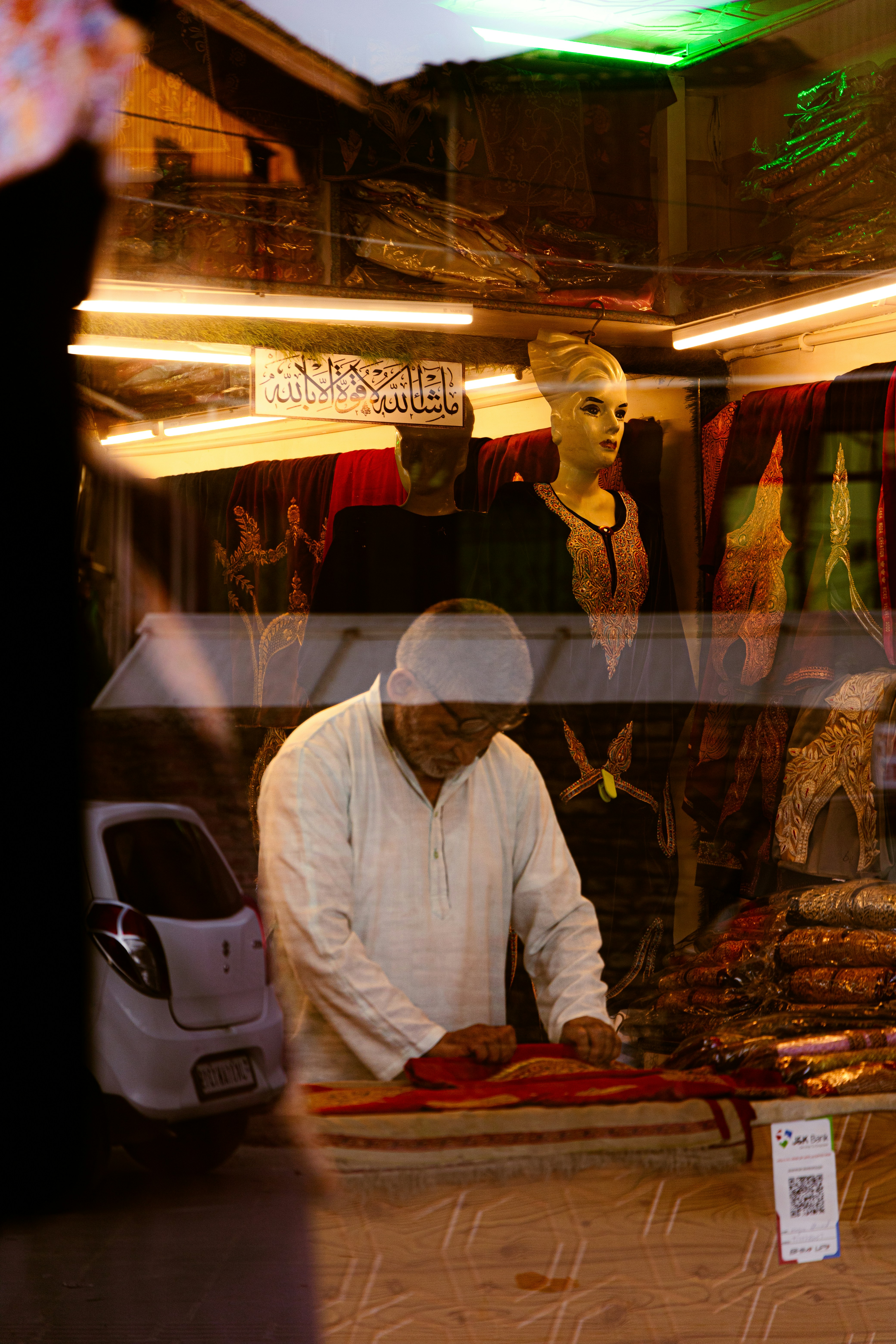 Glass-Window Tailor: Fabric, Neon, and a Market Moment
