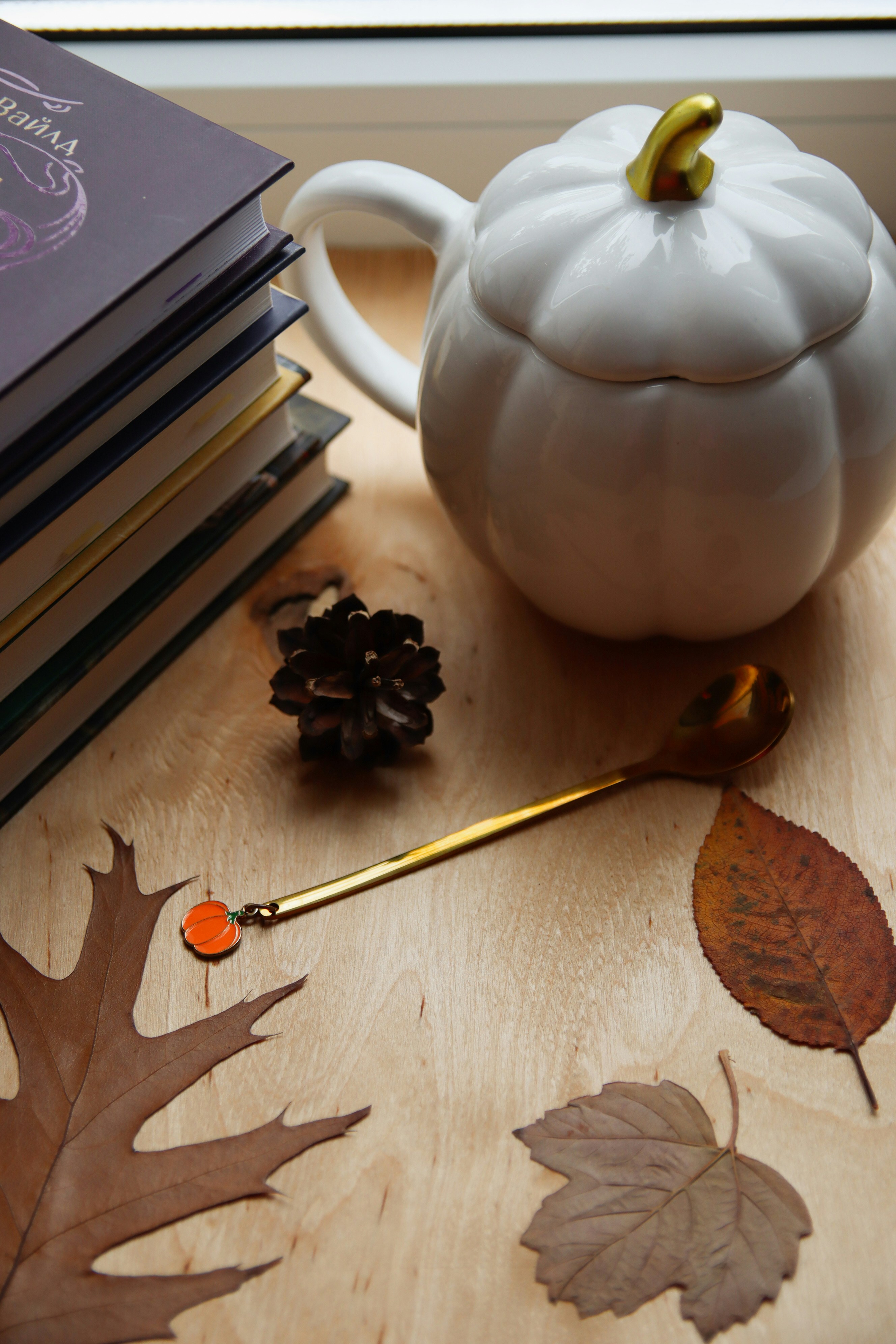 Autumn Quiet: The White Pumpkin Teapot Among Books and Leaves