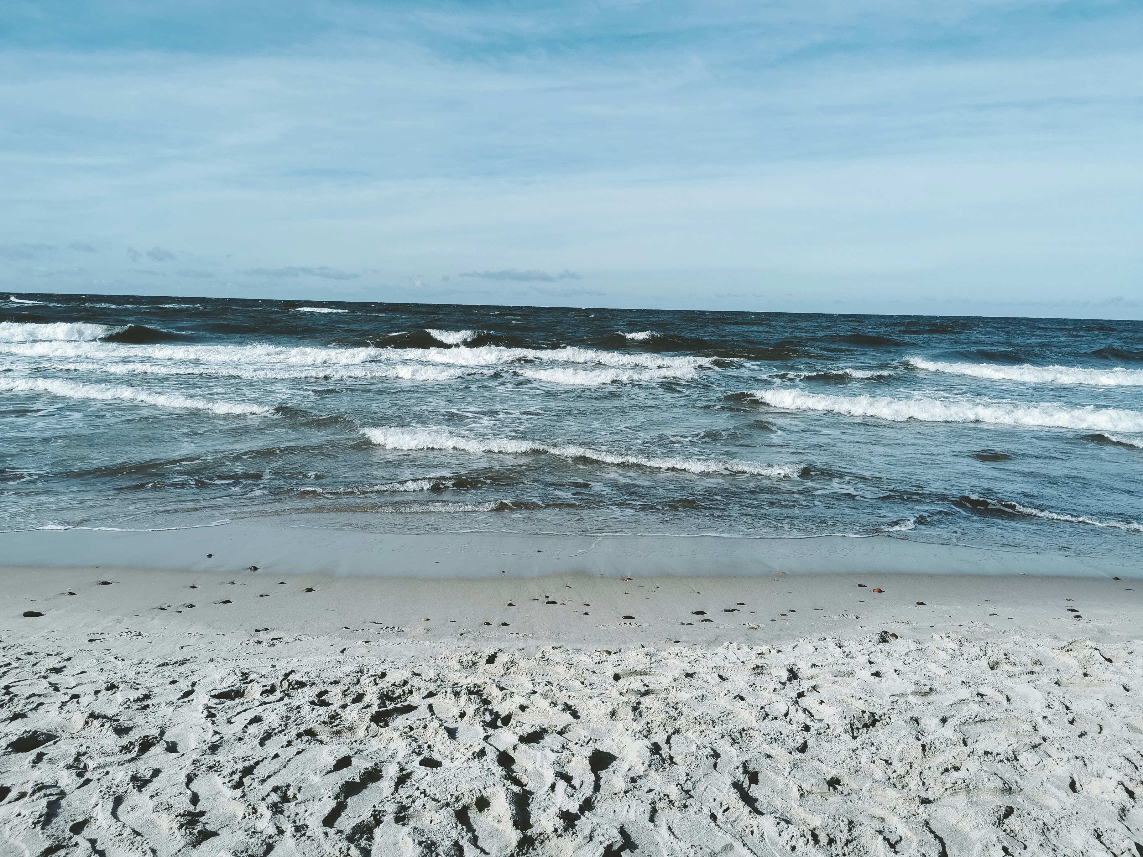 A view of the ocean from a sandy beach