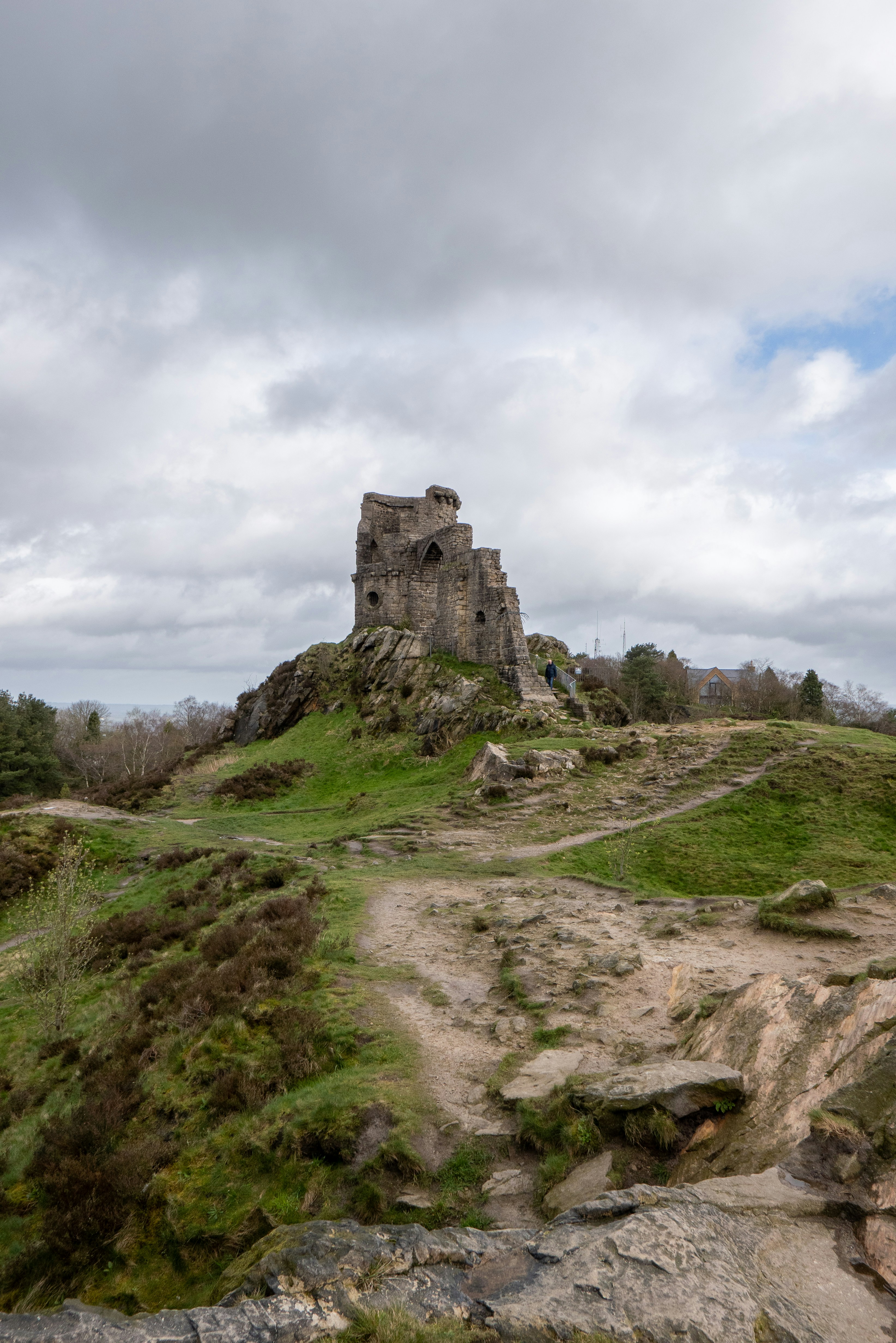 Ruin on the Ridge: Weathered Stone Watchtower Against a Cloudy Sky