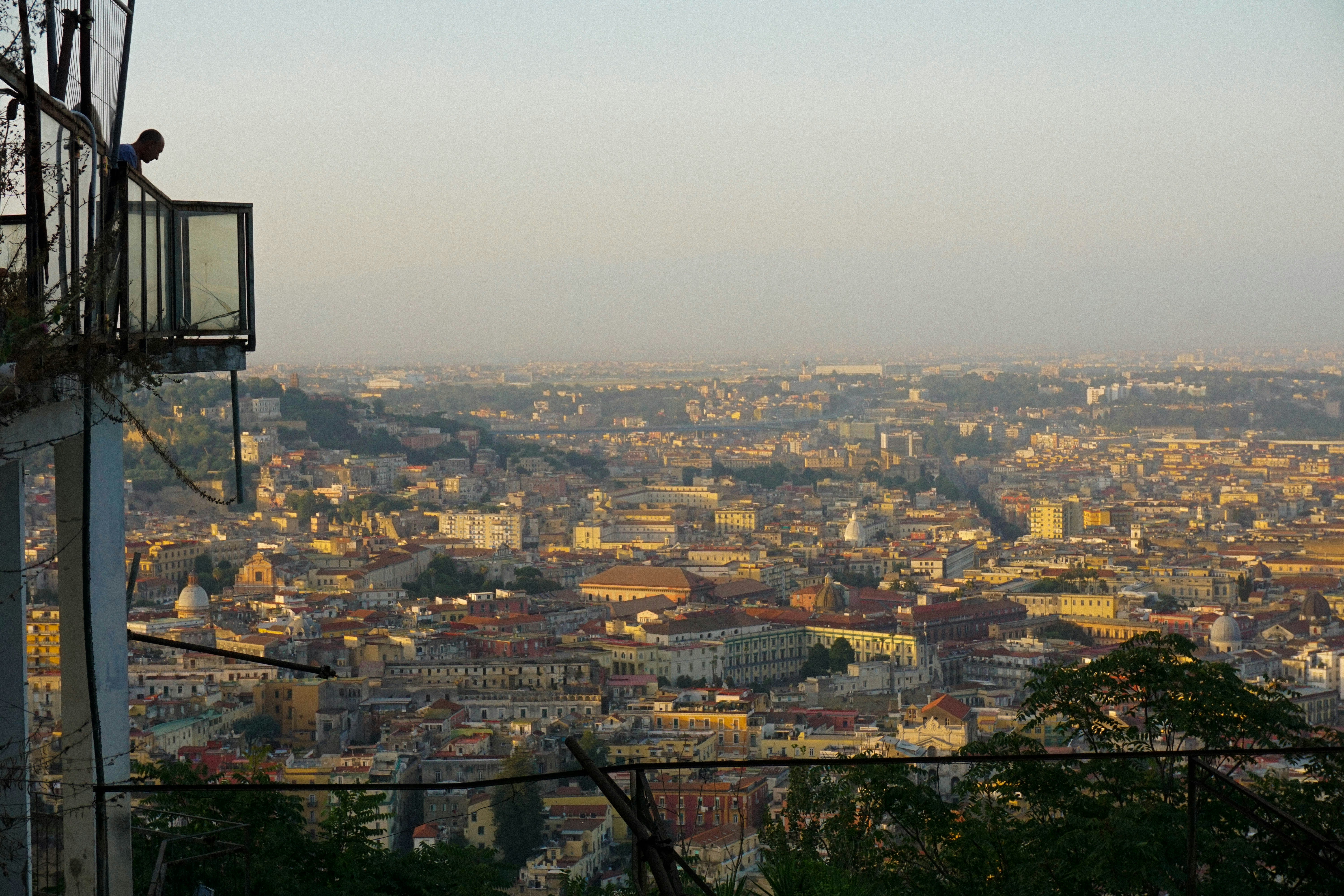 Horizon Over a Sunlit Metropolis: Balcony Overlook on a hillside