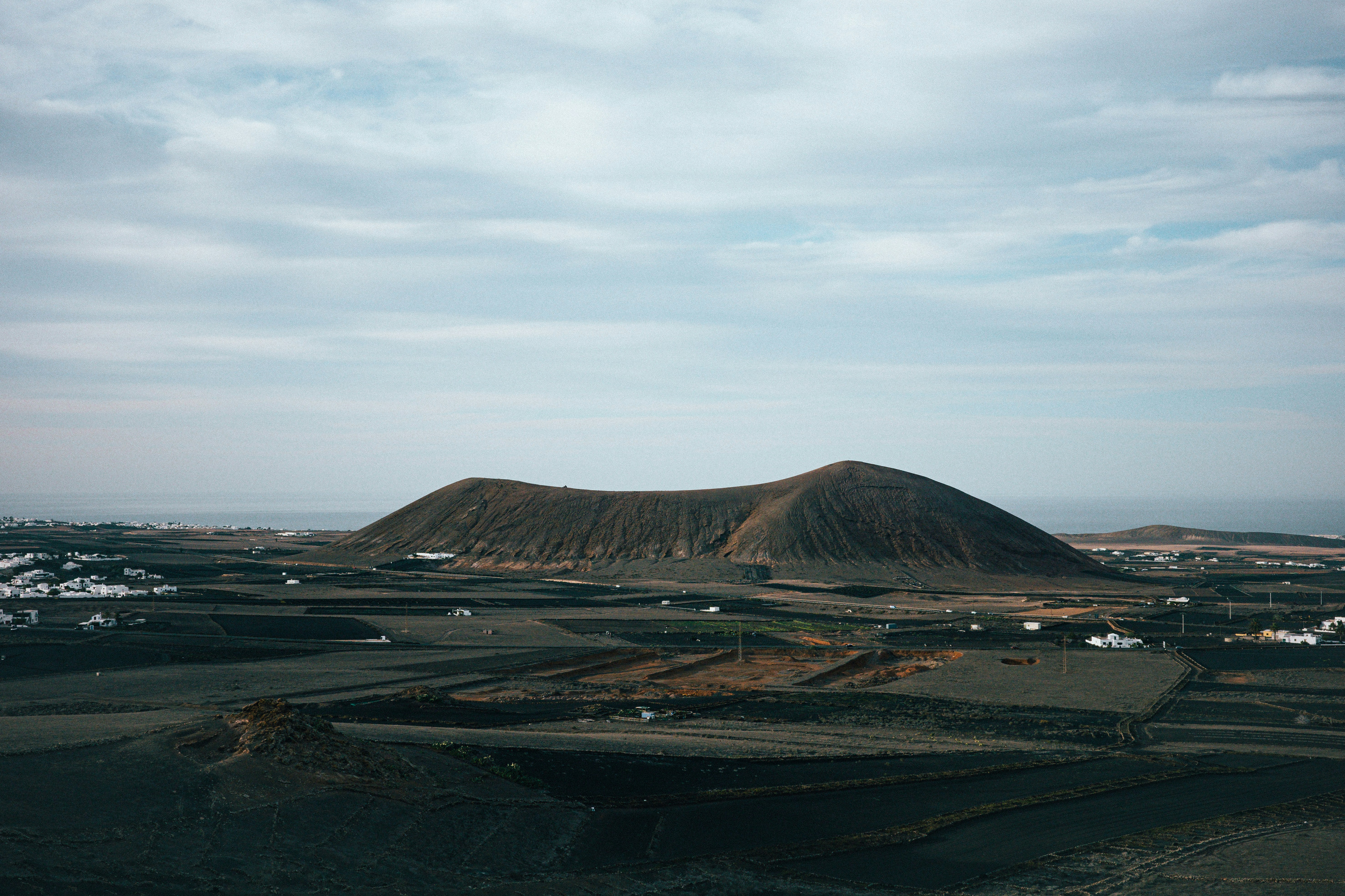 A large hill in the middle of a desert photo – Free Black Image on Unsplash