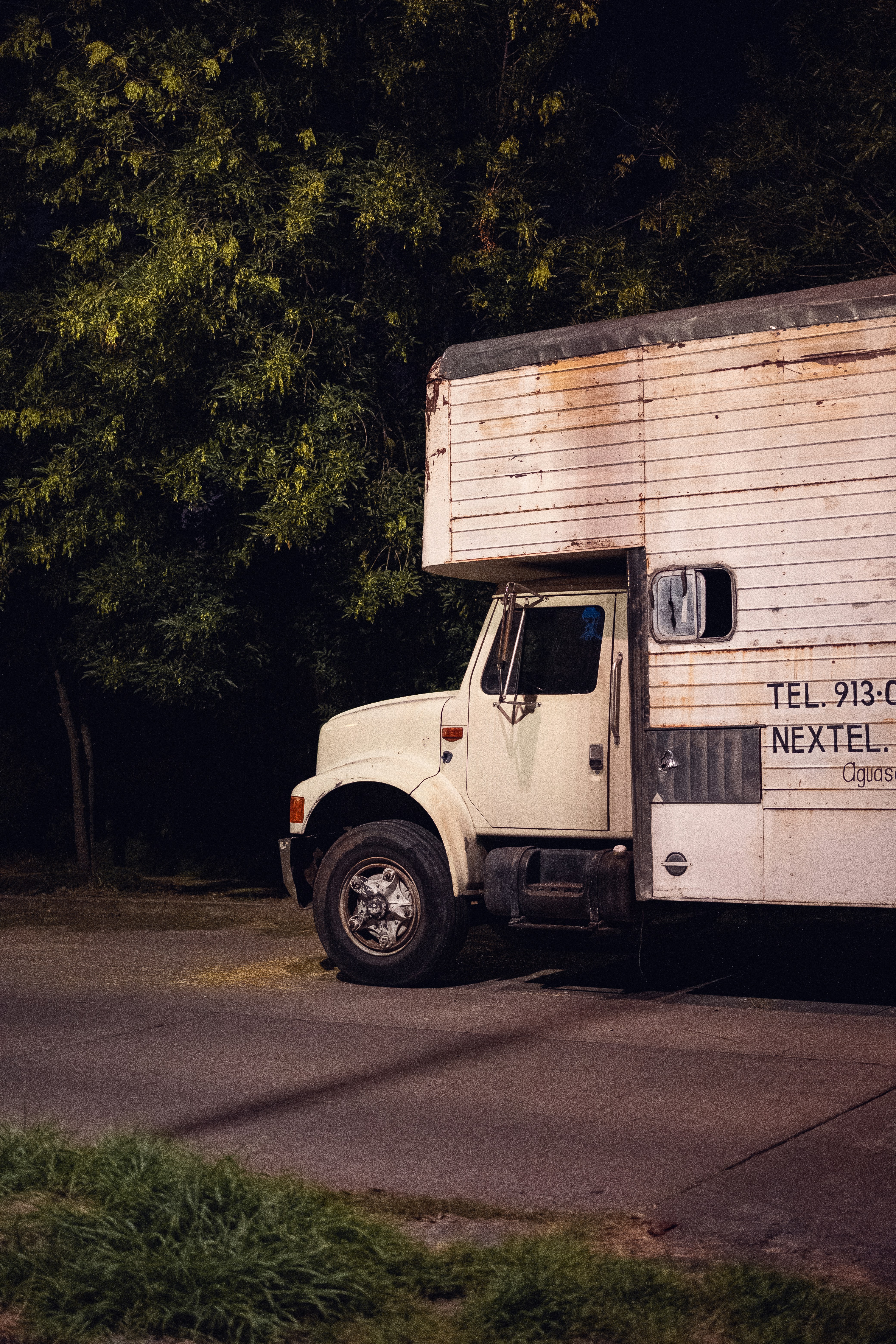Midnight Hauler: A Weathered Box Truck Resting by a Quiet Street