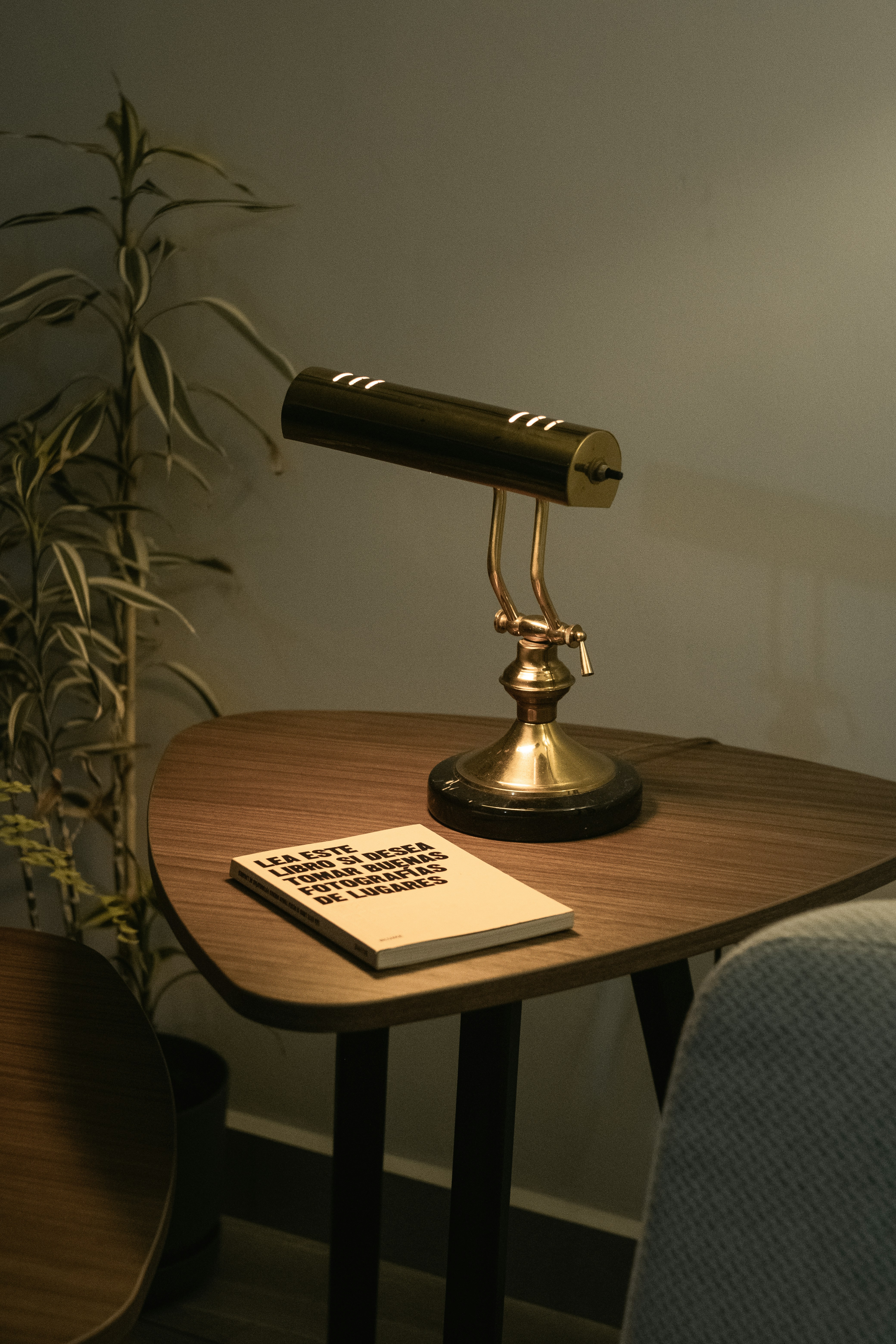 Brass Desk Lamp Casts a Warm Spotlight on a Quiet Reading Nook