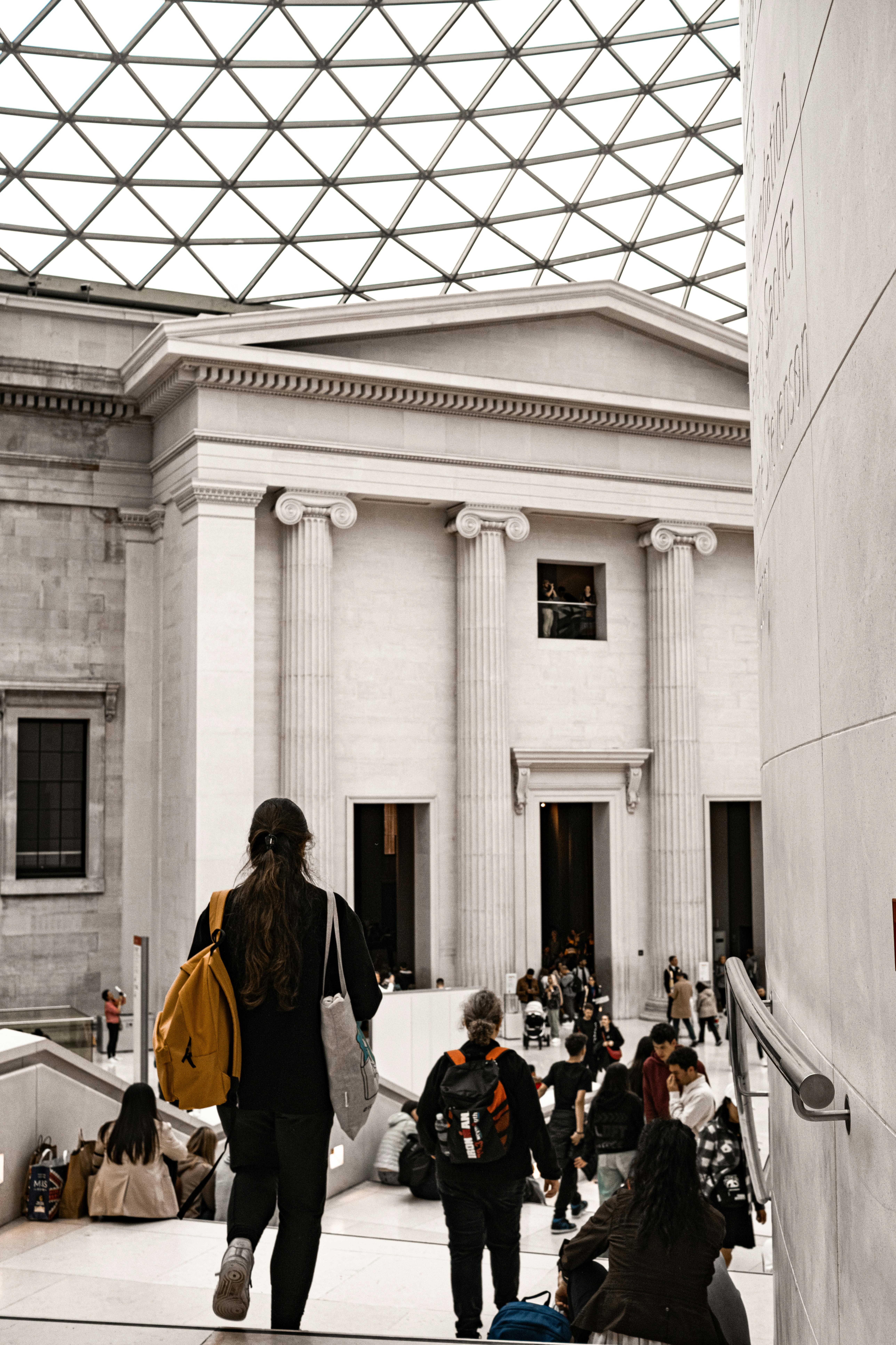 Amber Backpack at the Louvre: A Marble Threshold Beneath a Glass Dome