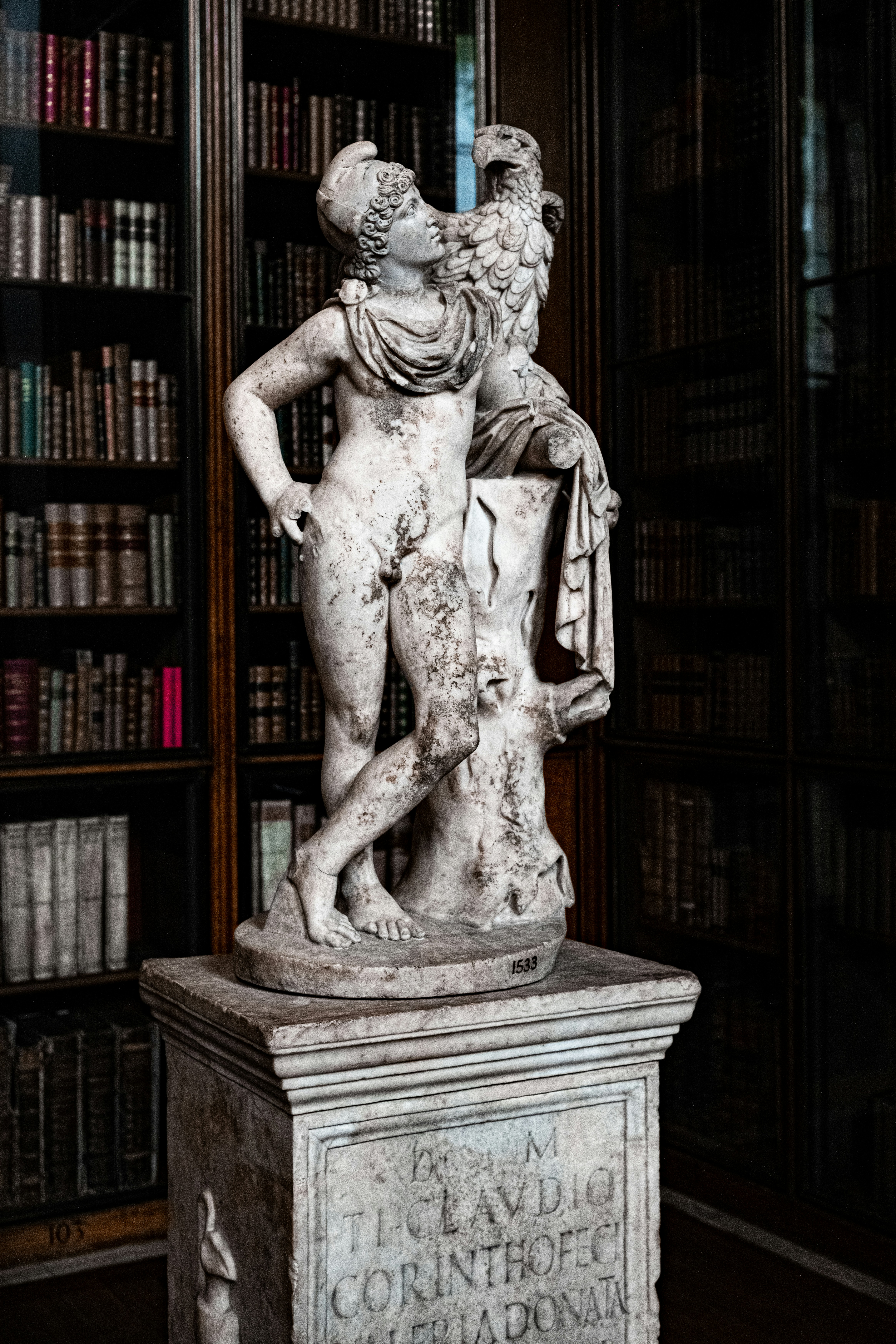 Cupid in the Library Alcove: Weathered Marble Among the Stacks