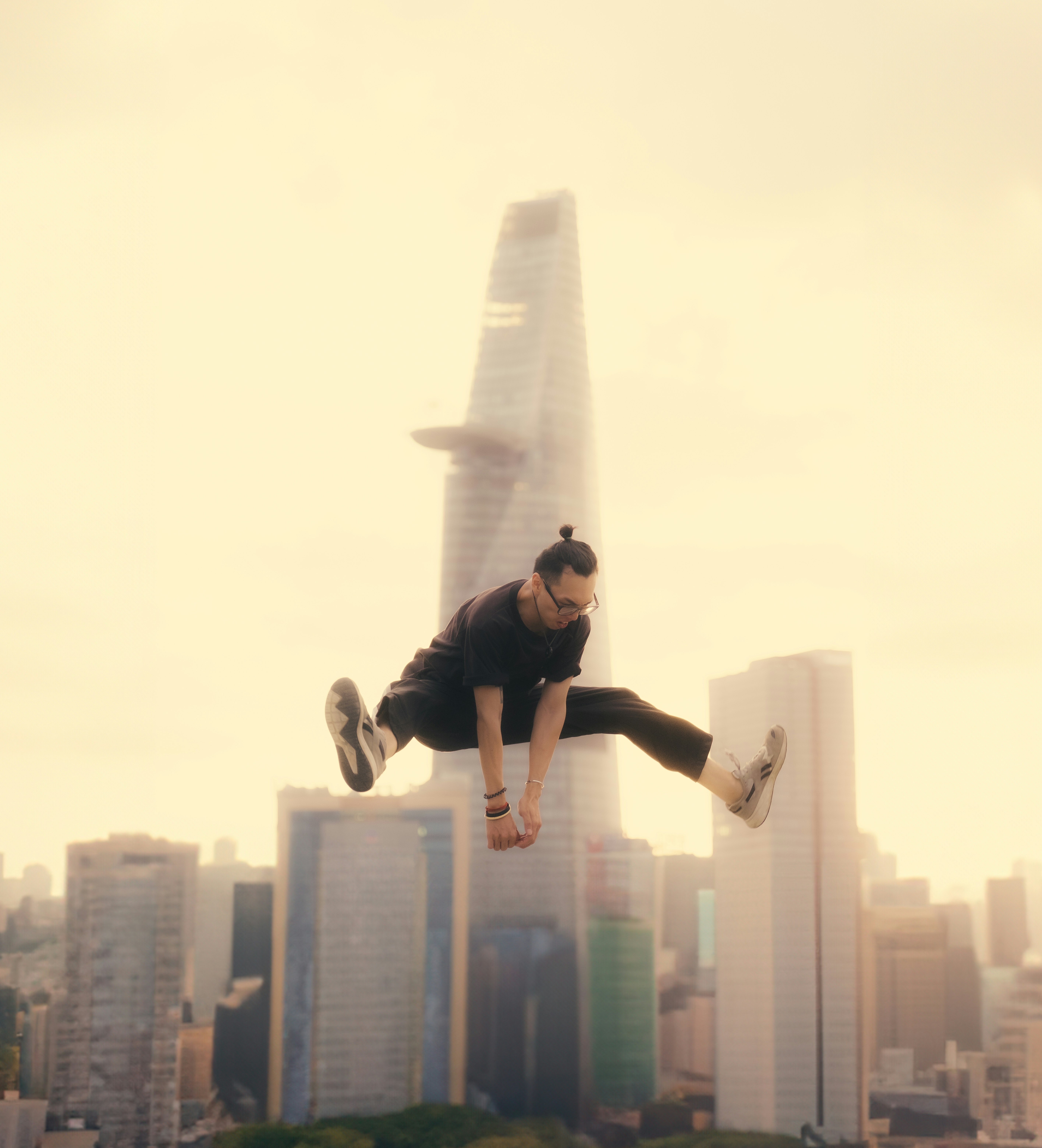 Midair Kickover: Urban Acrobat Suspended Above the City