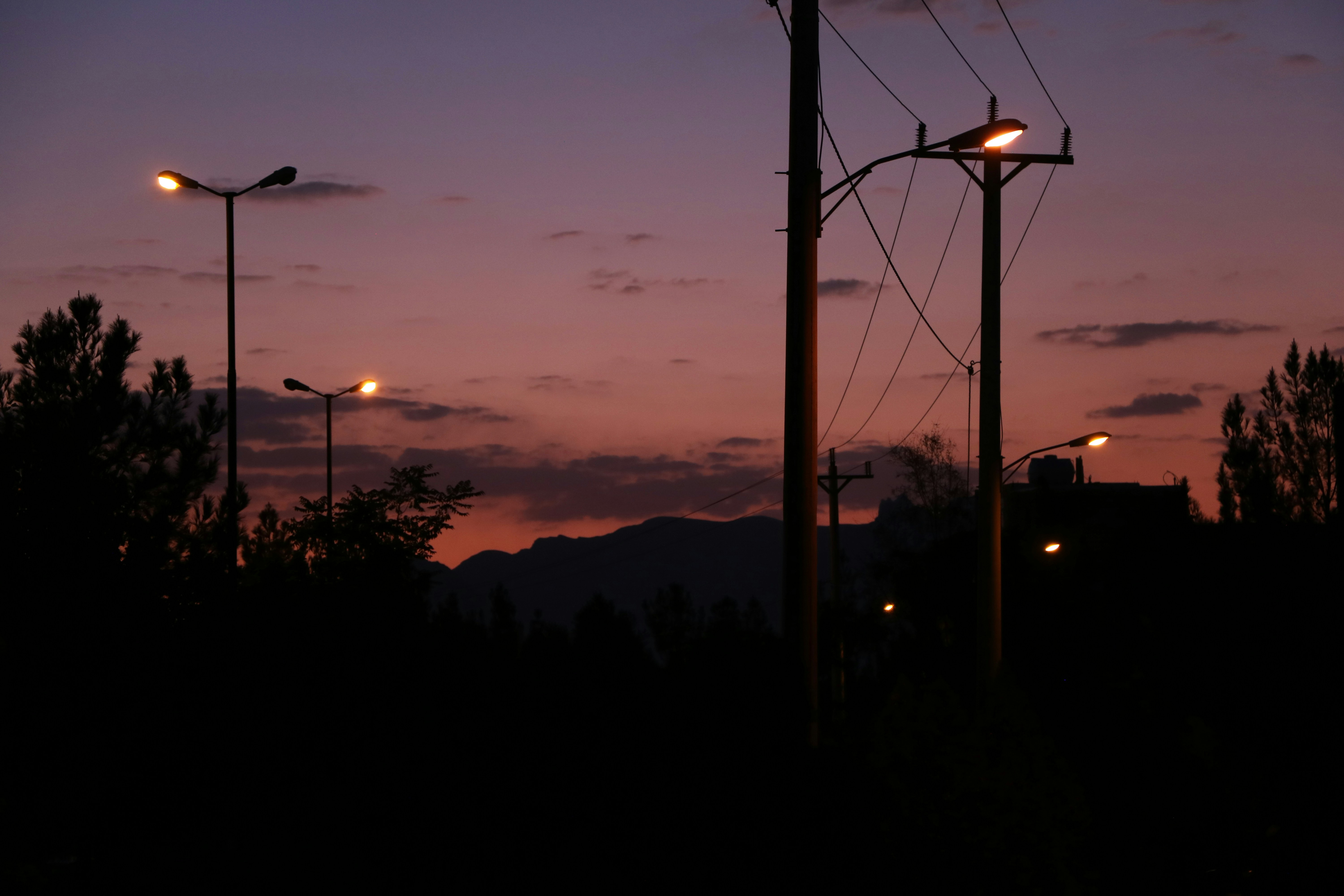 Dusk Gradient: Streetlamps Framing a Quiet Mountain Ridge
