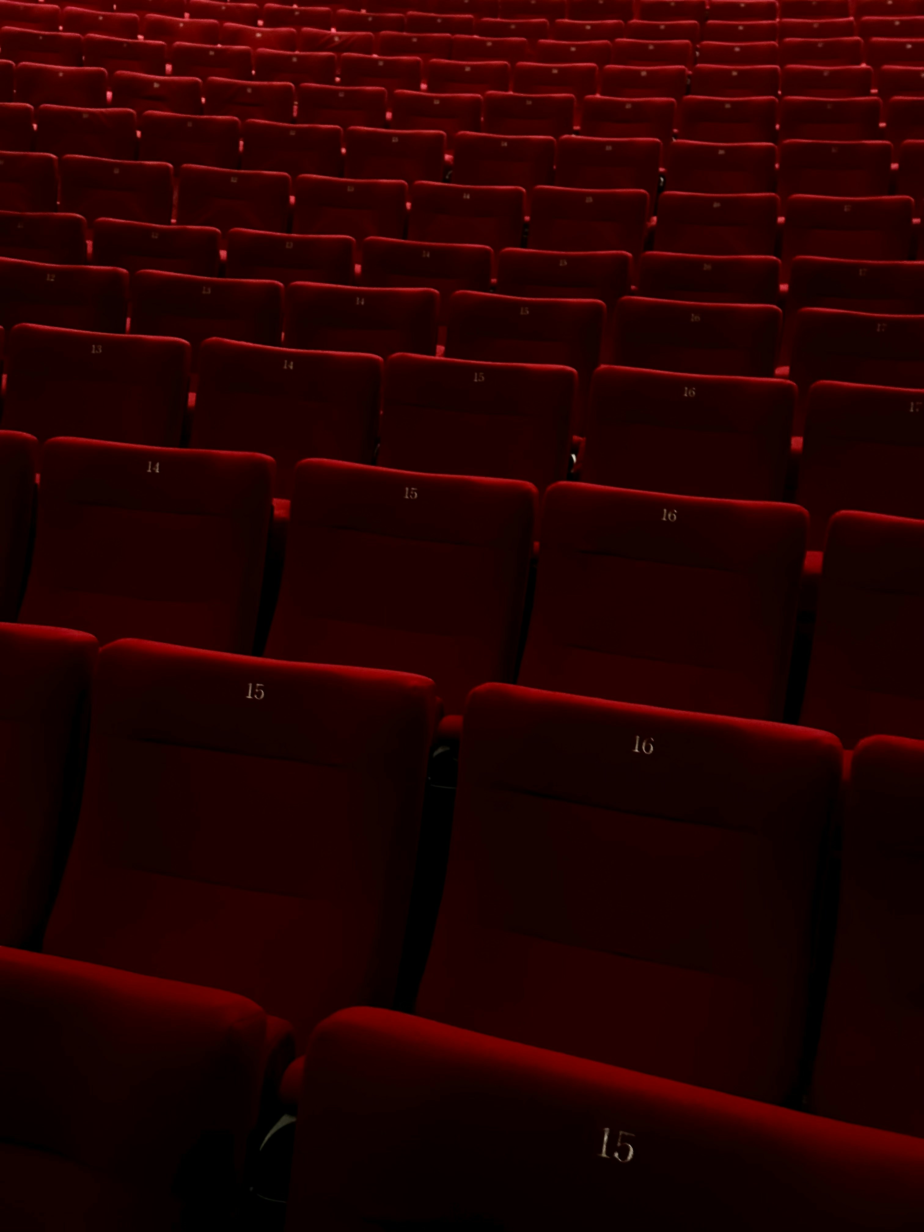 A row of red seats in a theater