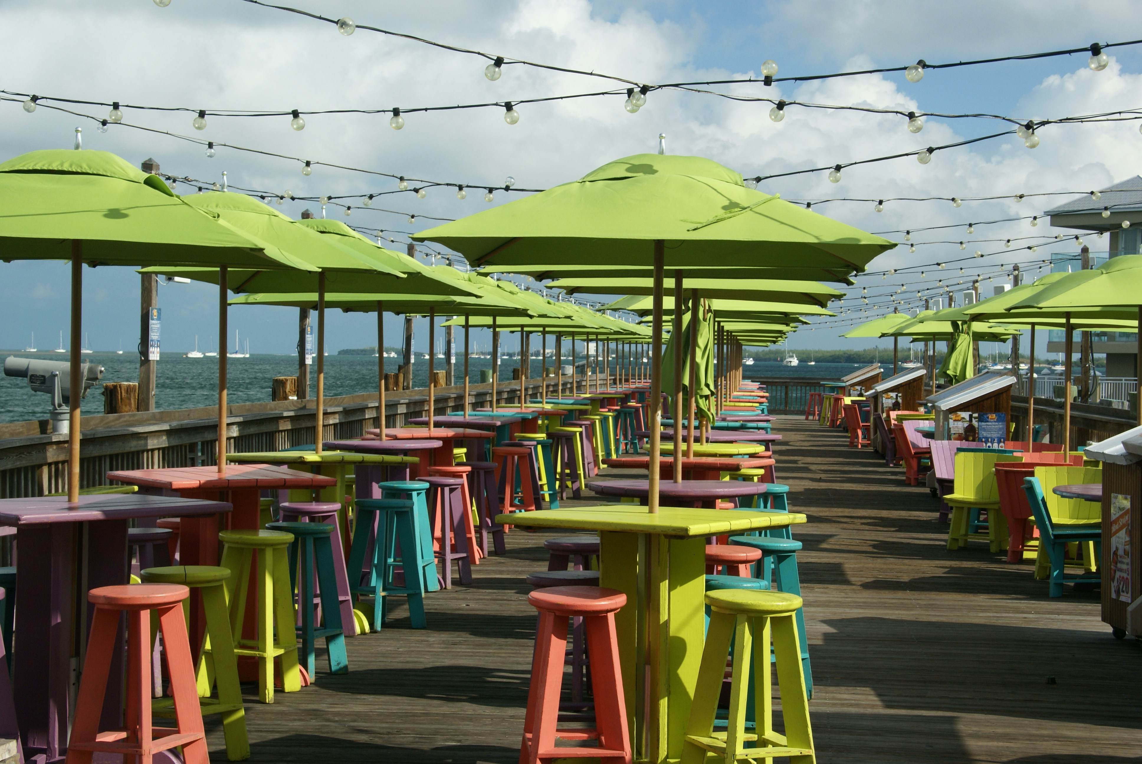 A row of tables with umbrellas over them photo – Free Terrasse Image on ...