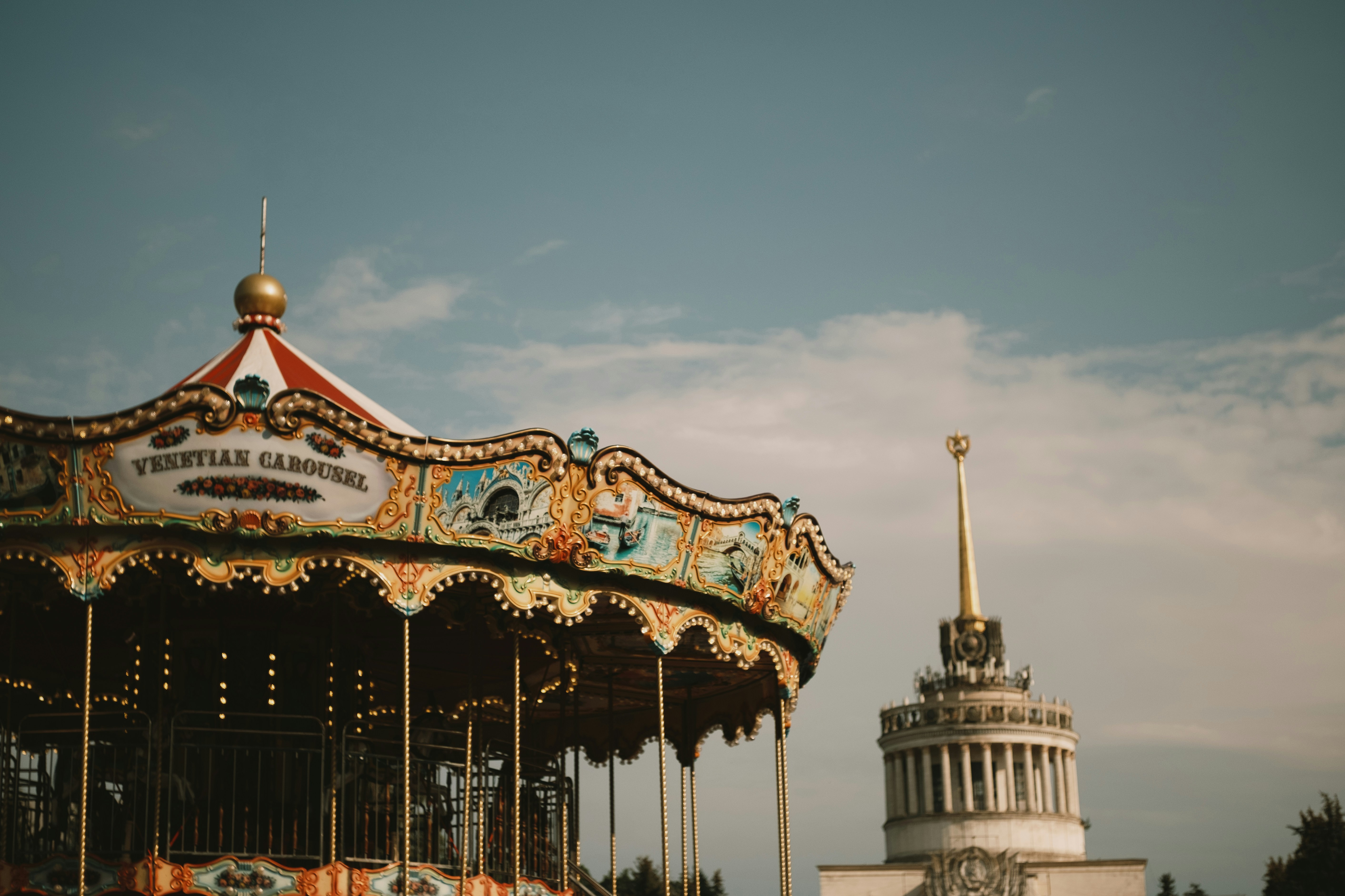Carousel Beneath the Sky: Vintage Whimsy with City Tower in Soft Light
