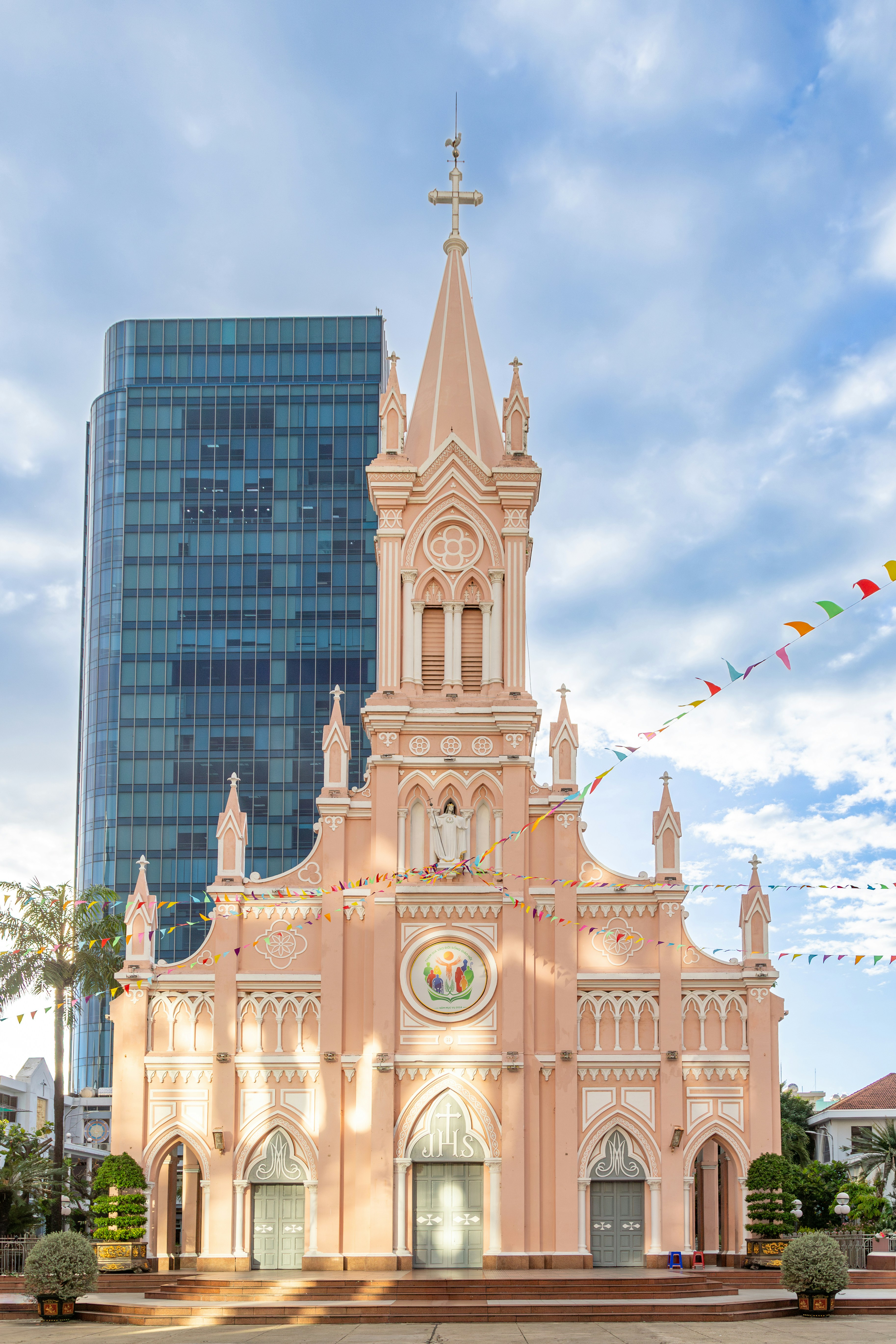A large pink building with a cross on top of it photo – Free Da nang ...