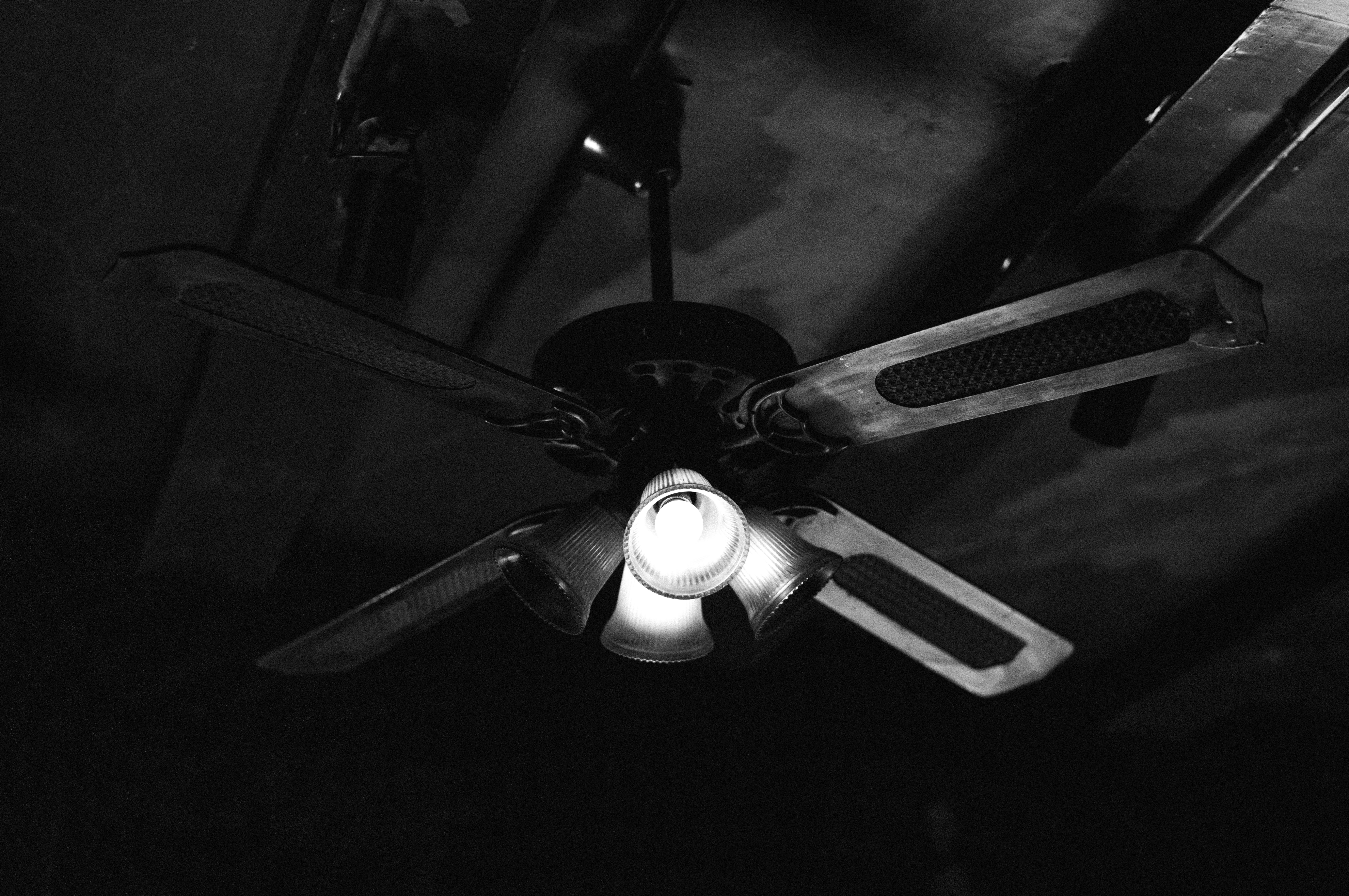 Low-Light Rotation: A Central Ceiling Fan in Quiet Darkness