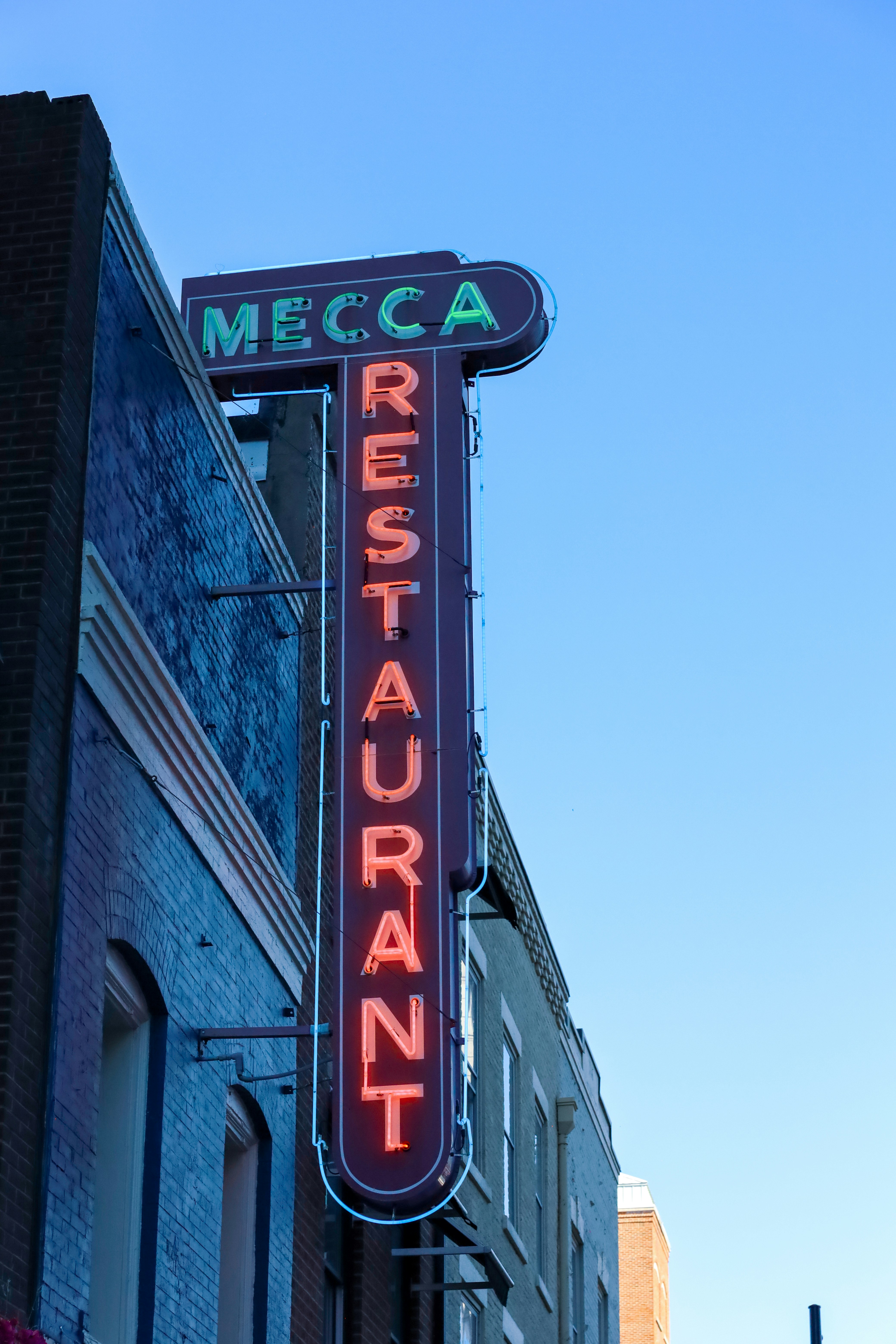 Neon Signage on a Downtown Brick Facade