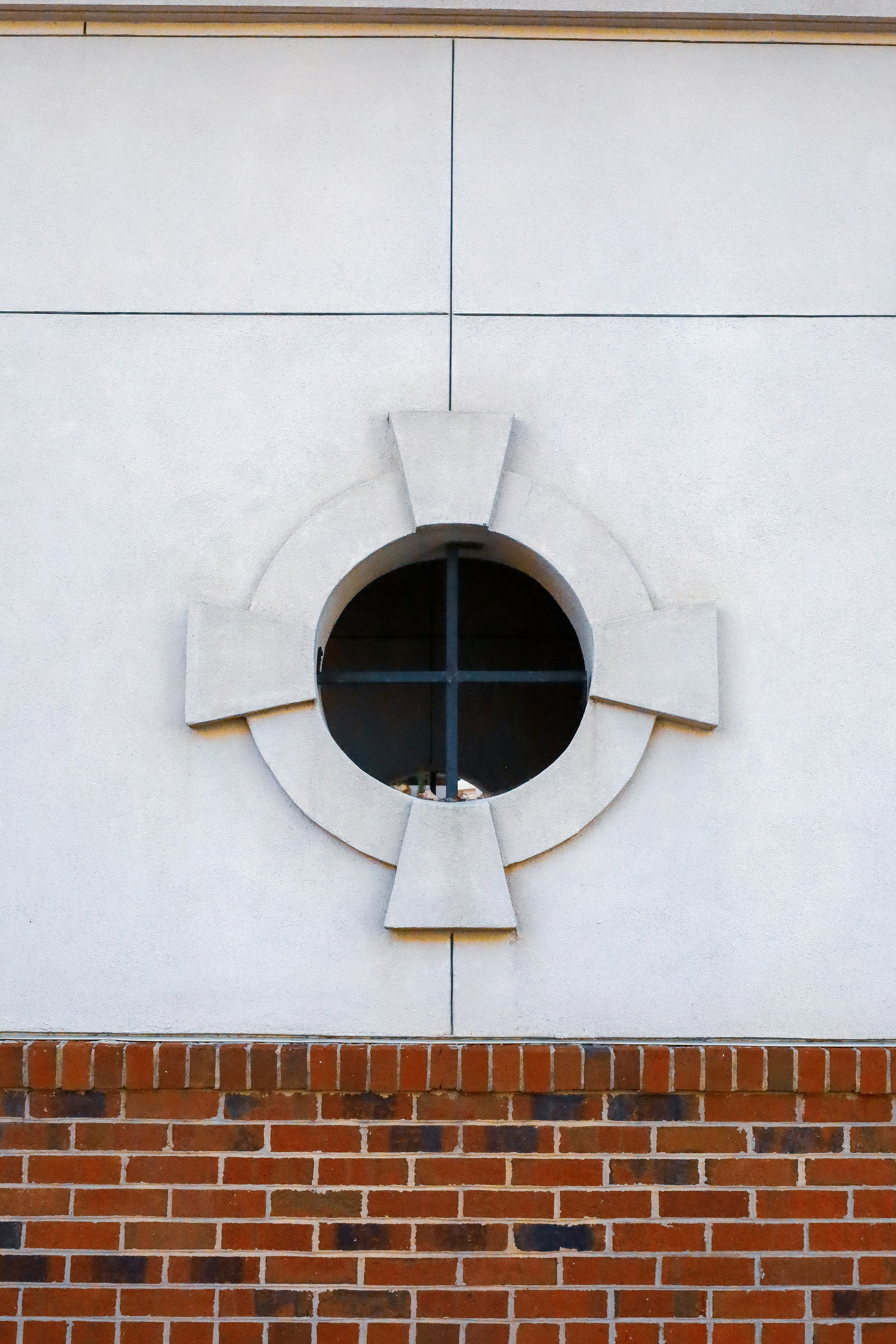 Round Window, Straight Lines: A Quiet Study in Concrete and Brick