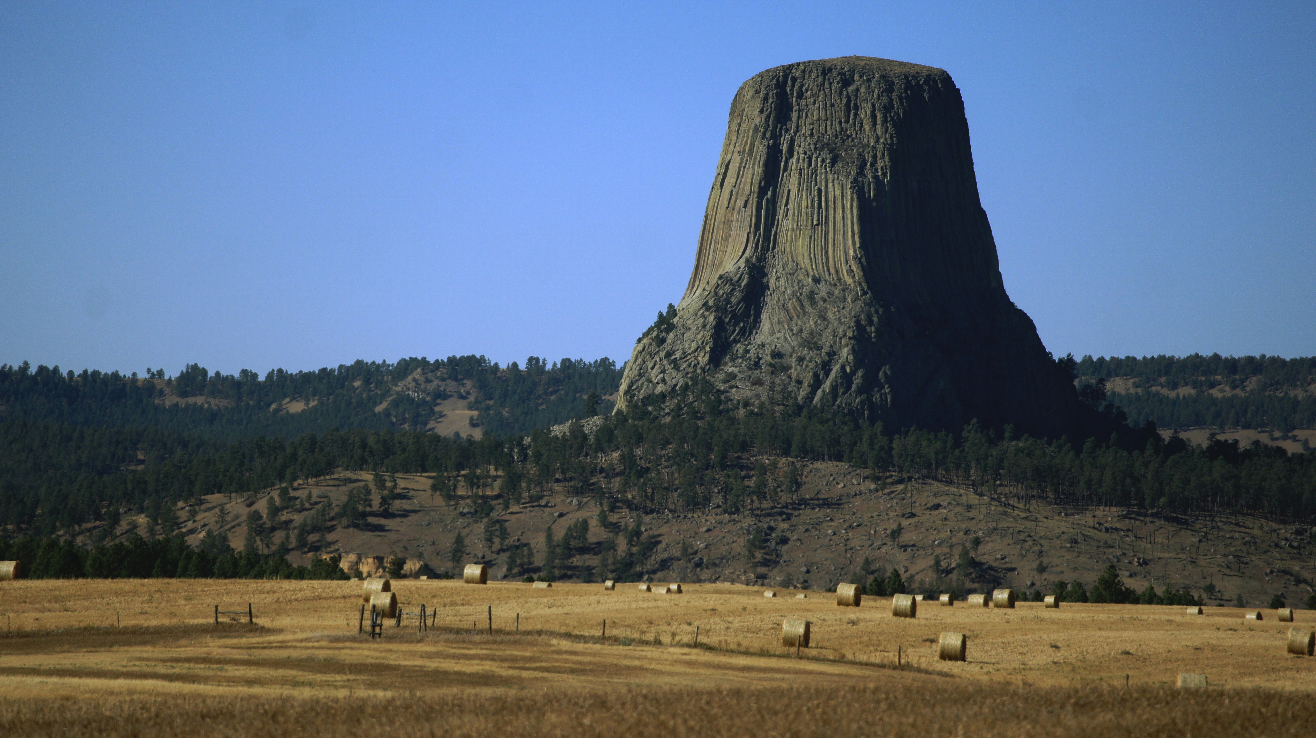 A large rock formation in the middle of a field photo – Free Devils ...