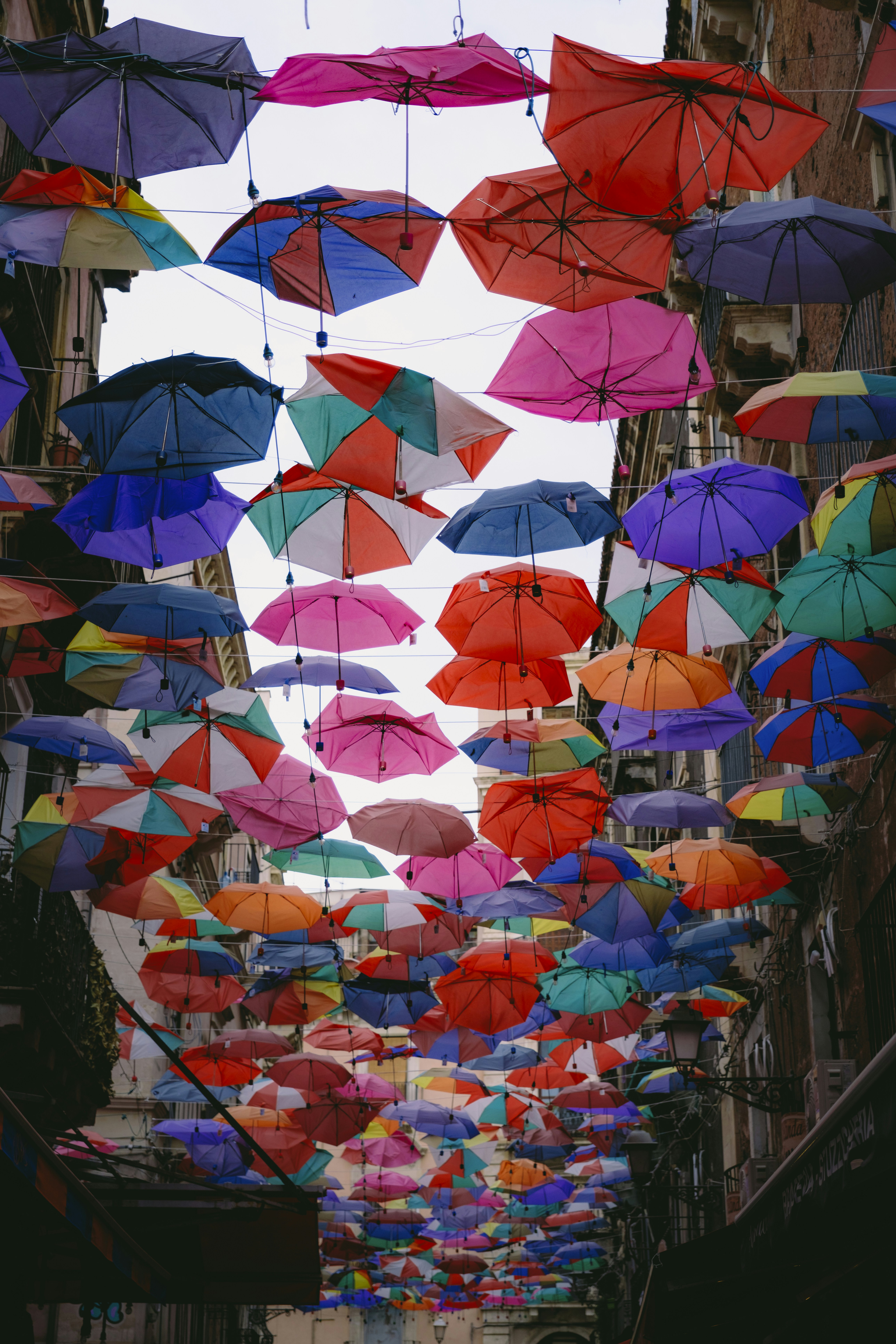 A street filled with lots of colorful umbrellas