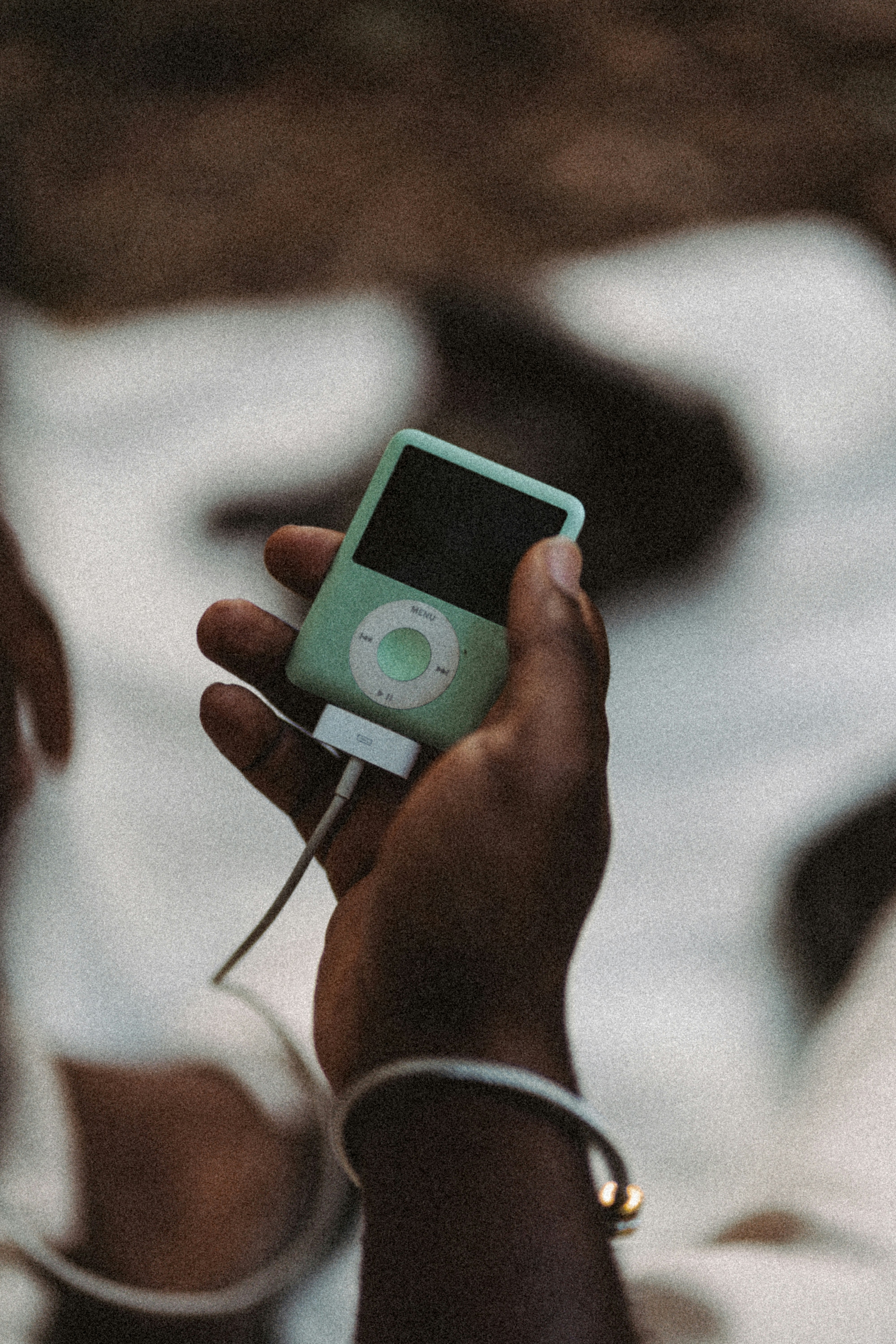 A person holding an ipod in their hand