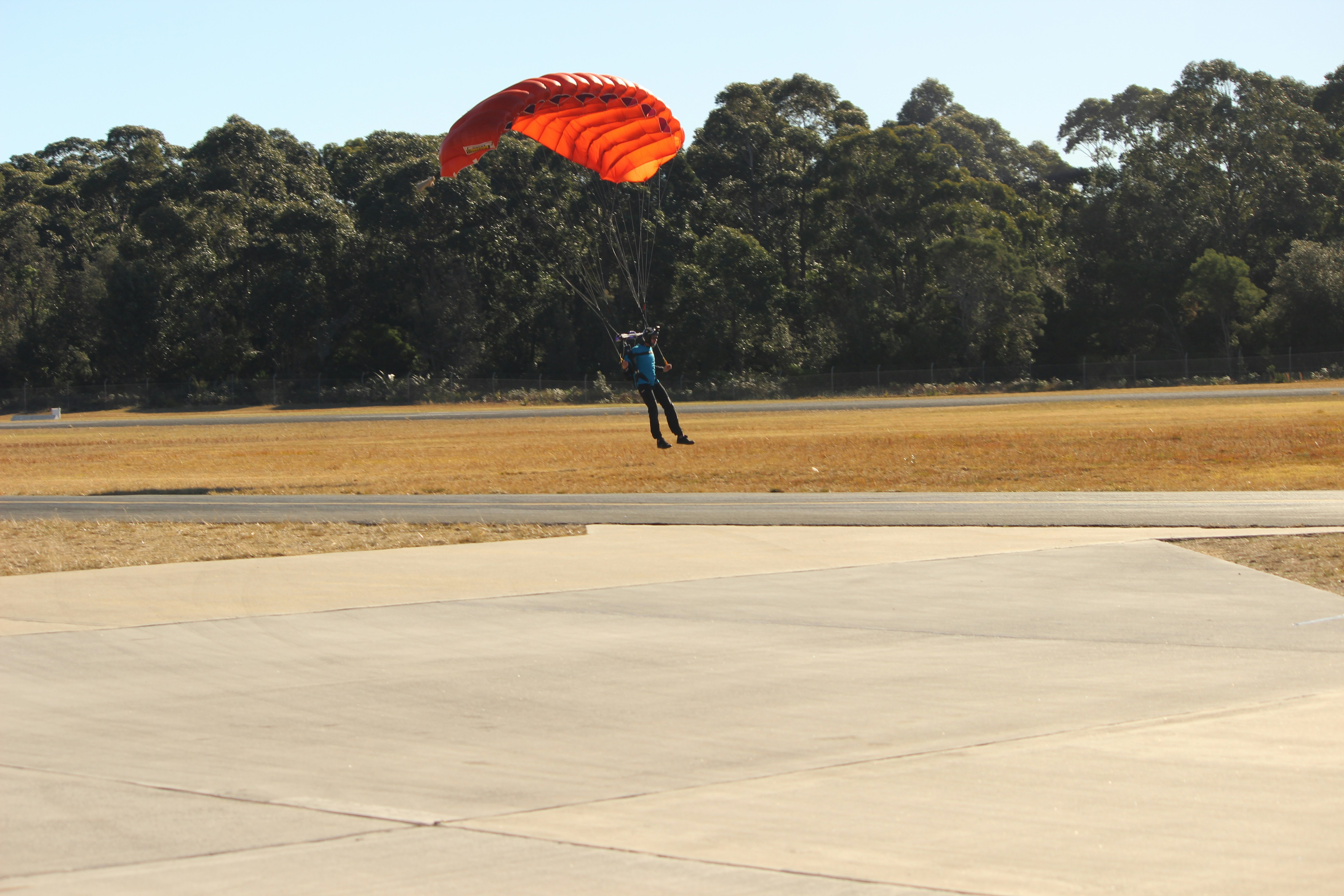 A person is flying a large orange kite photo – Free Human Image on Unsplash