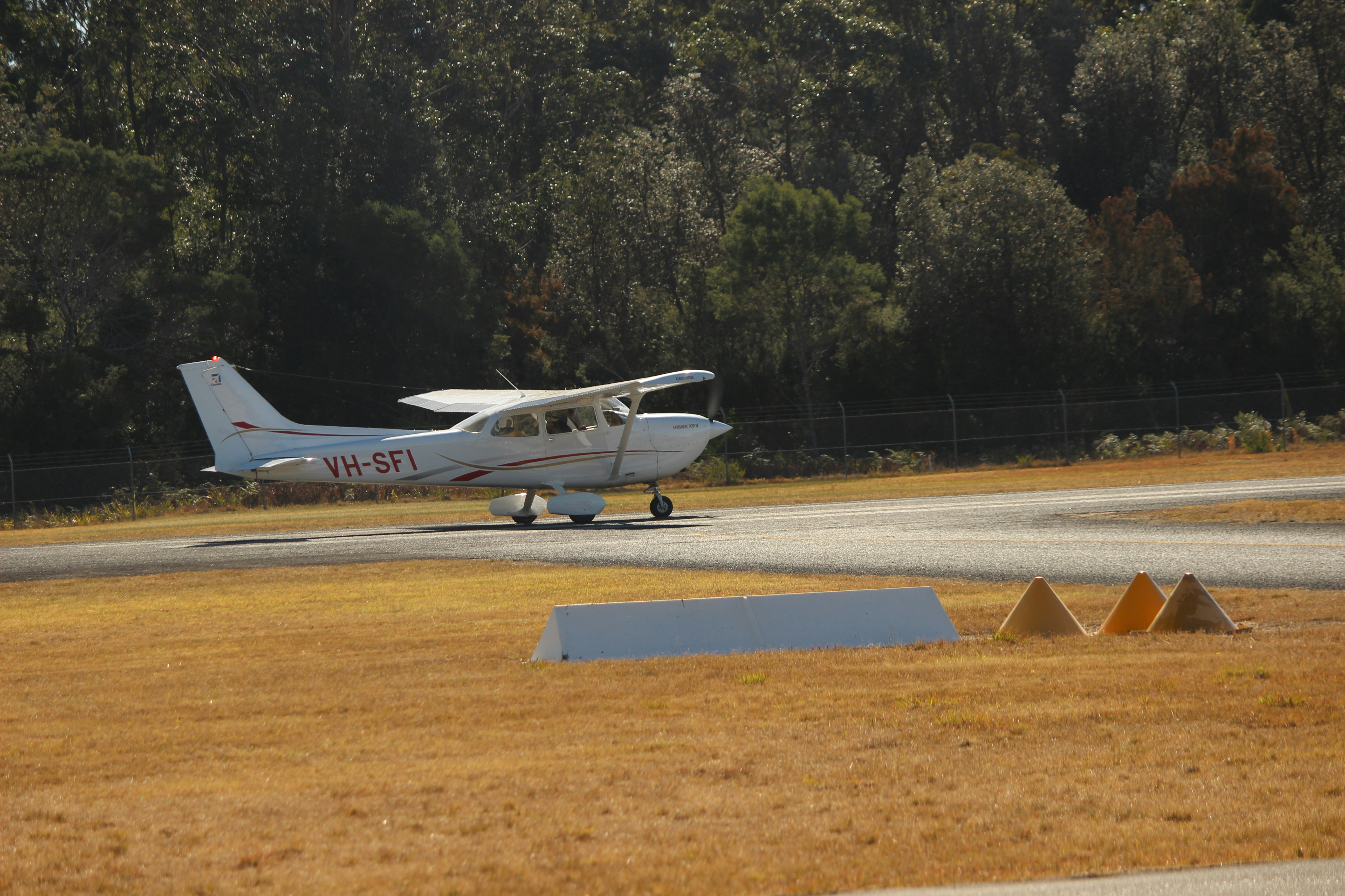 Take off, Moruya Airport, NSW, Australia | A small plane on a runway with trees in the background