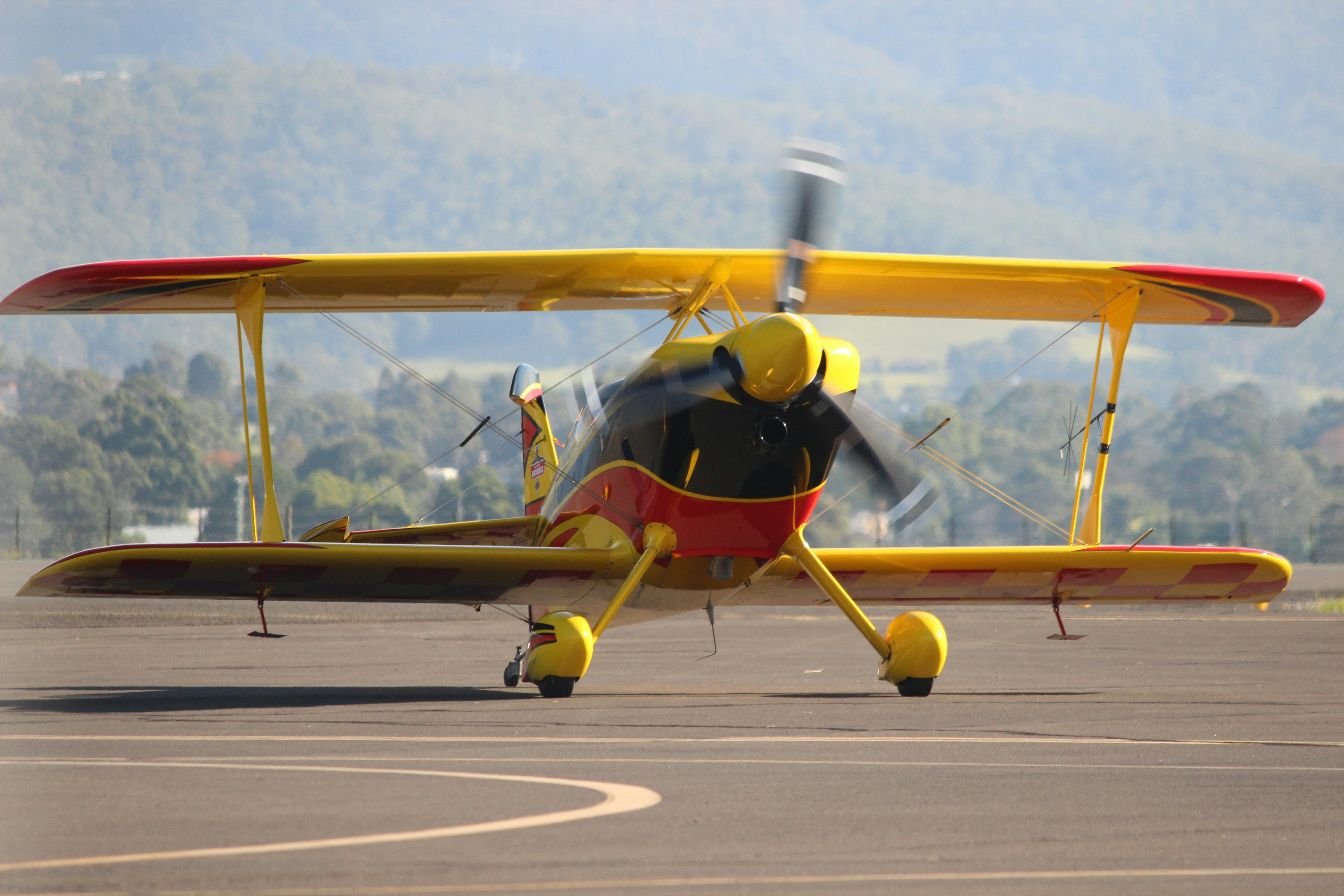 Yellow-Red Biplane on a Quiet Airport Tarmac