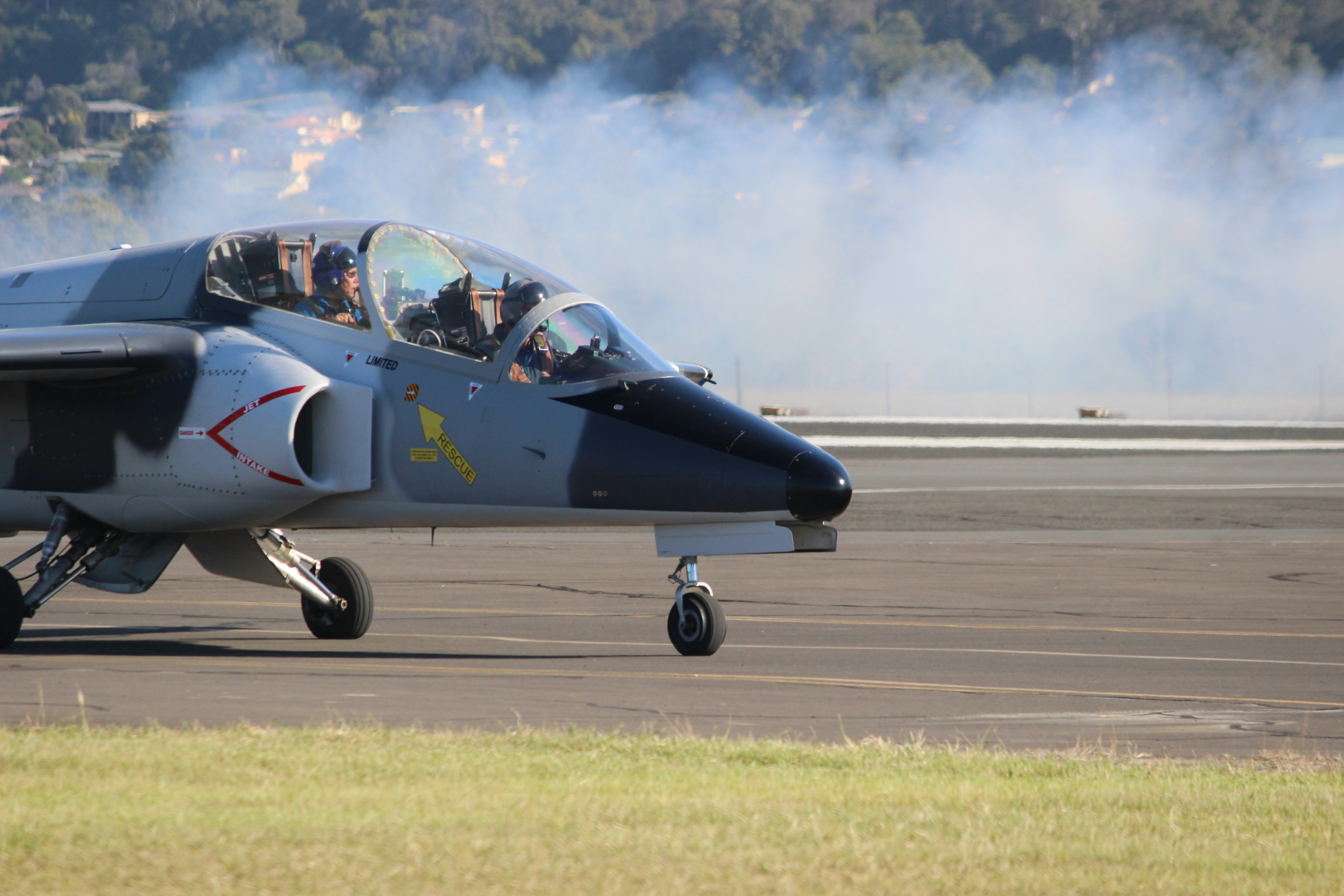 A fighter jet sitting on top of an airport runway photo – Free Human ...