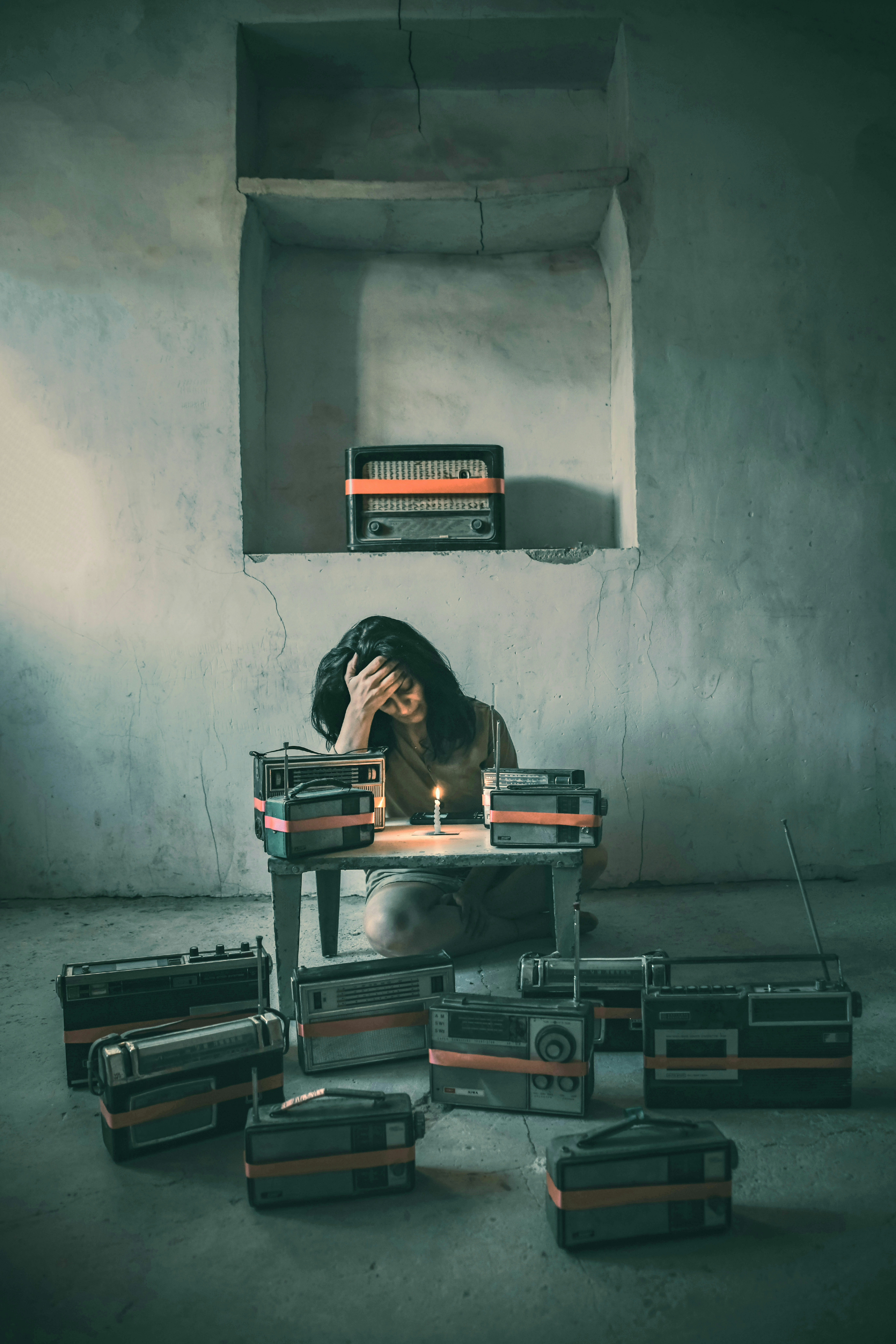 Solitary Wake: A Candlelit Moment Surrounded by Echoing Radios
