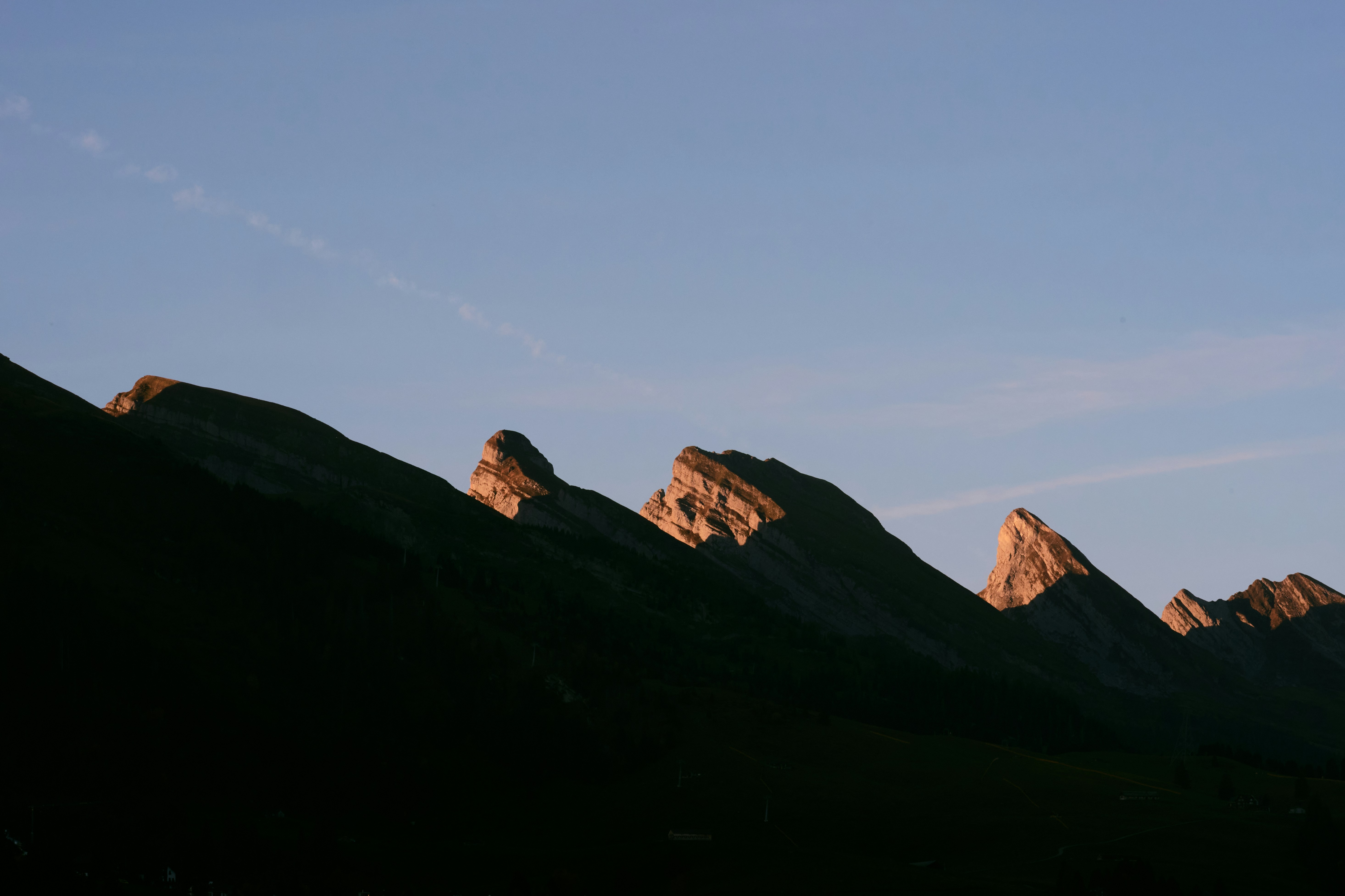 A group of mountains in the distance with a blue sky in the background ...