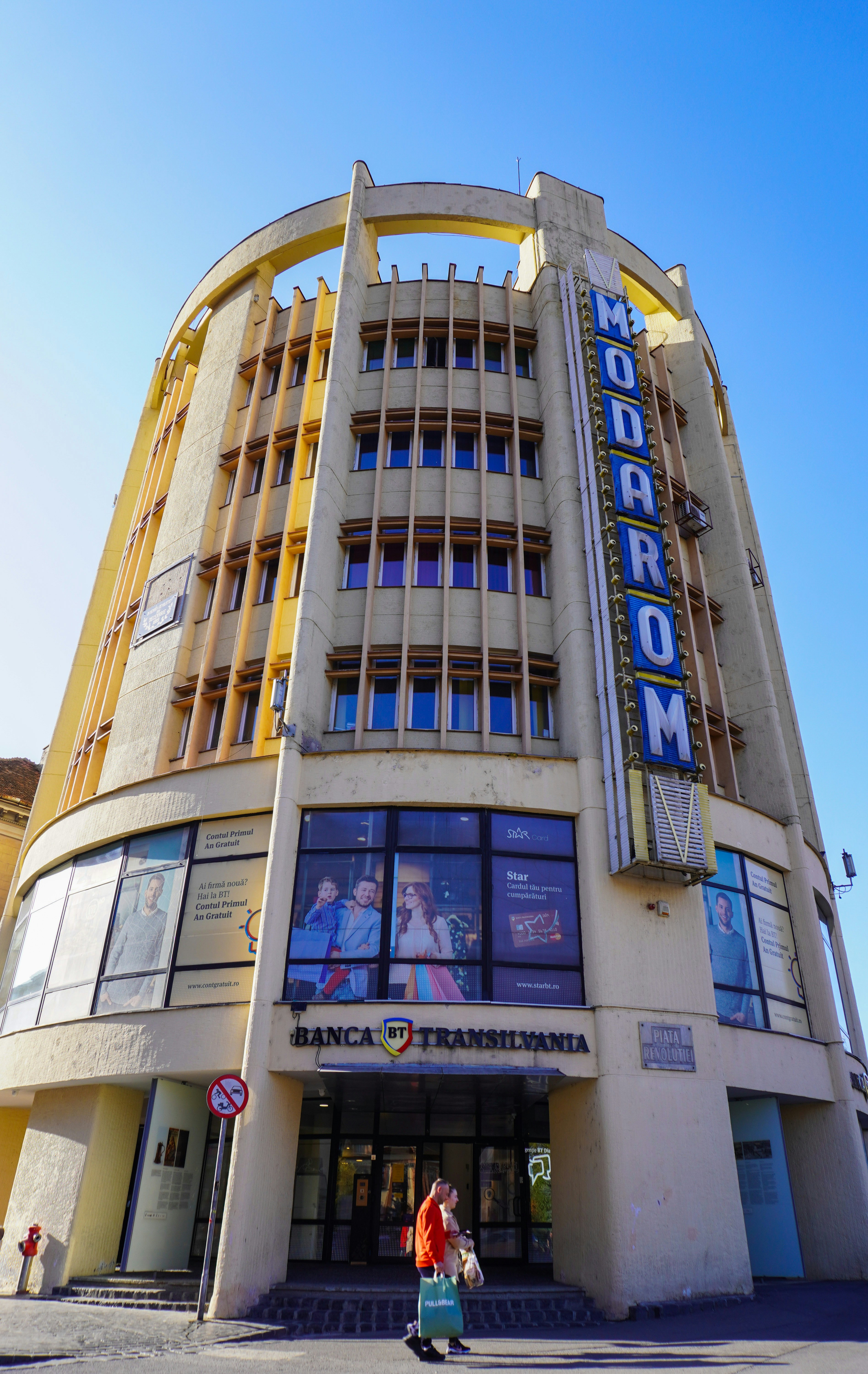 A tall building with a sign on the front of it