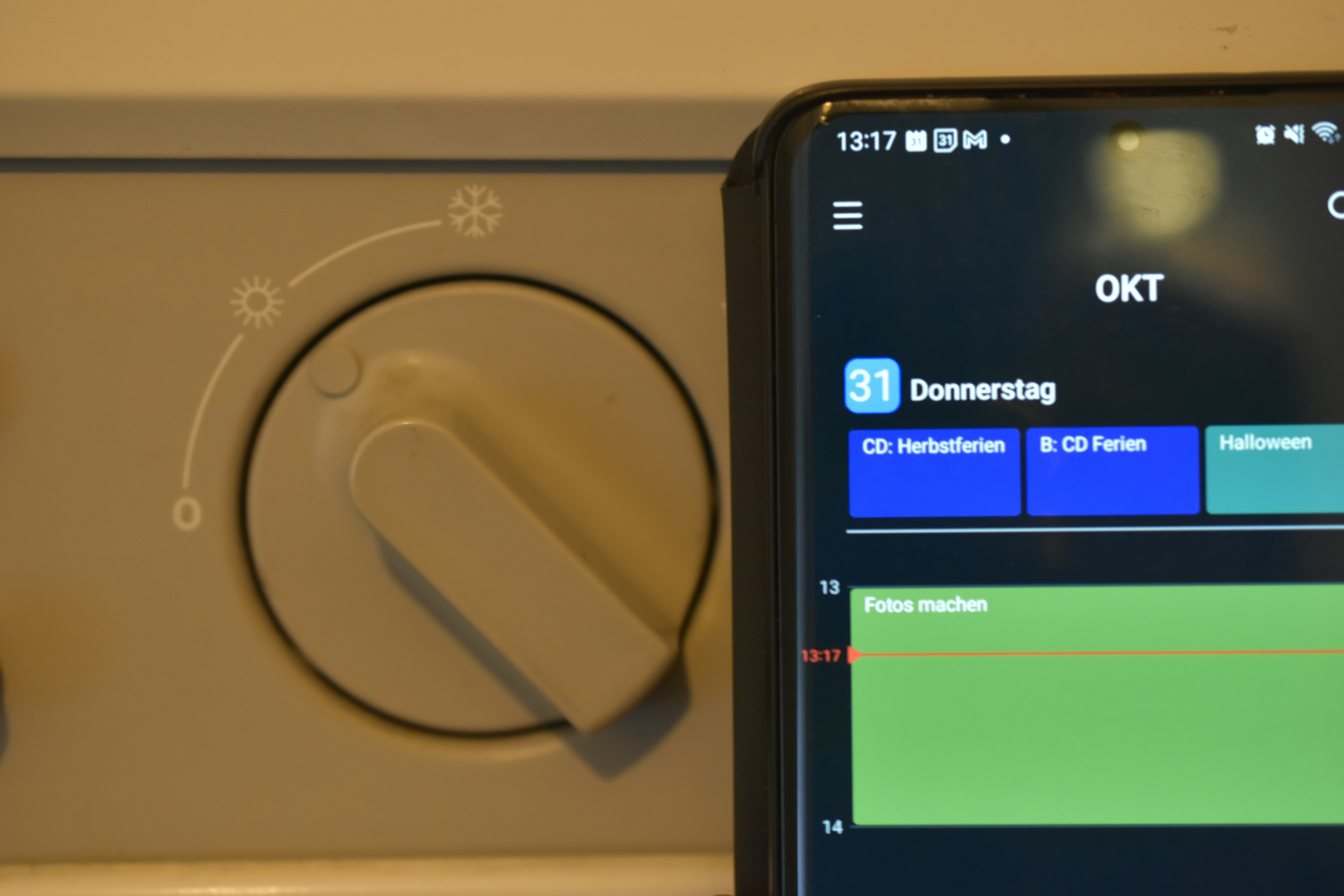 A cell phone sitting on top of a counter next to an appliance photo ...