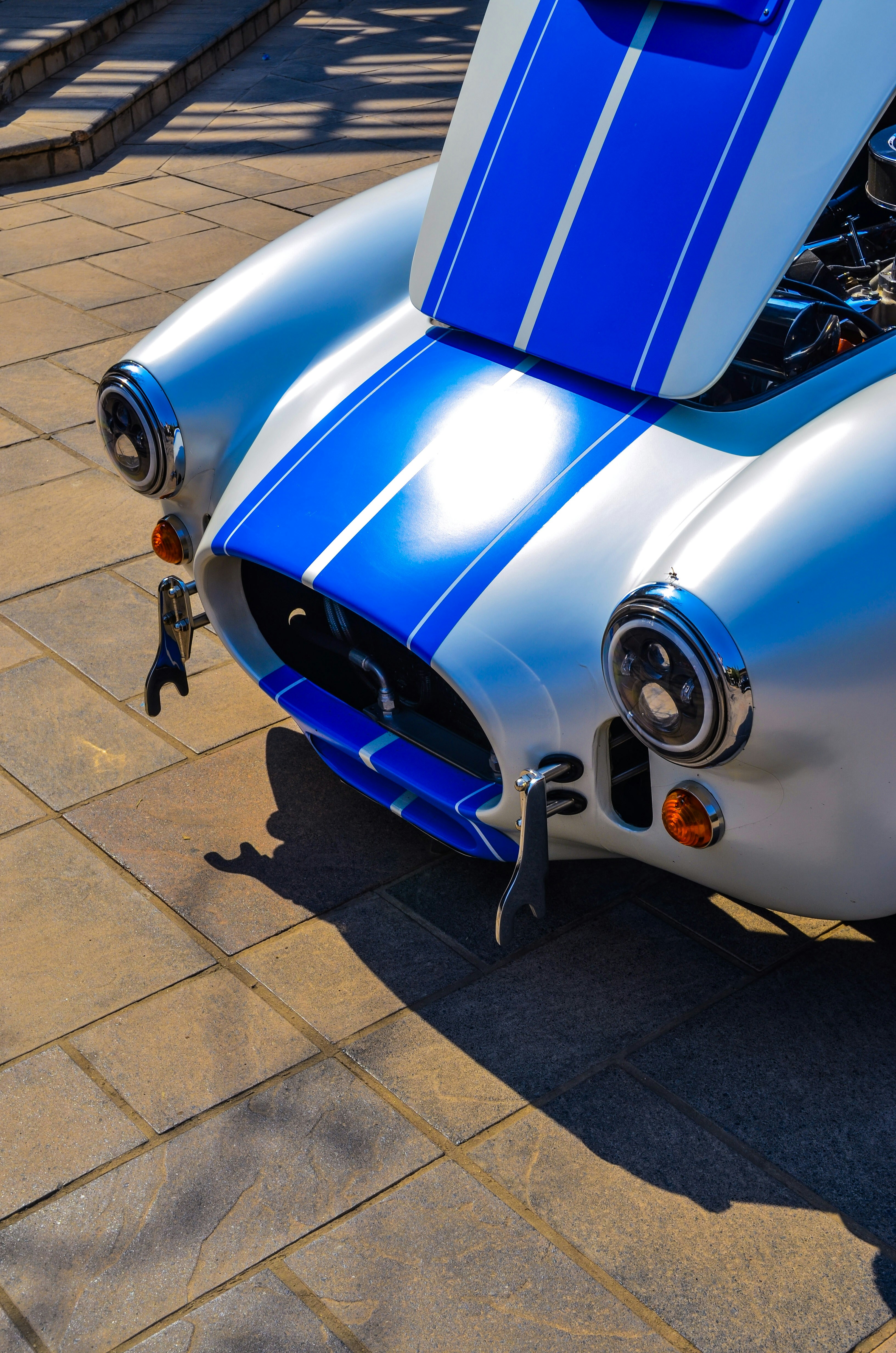 Azure Stripes, Chrome Glow: Front View of a Classic Race-Car