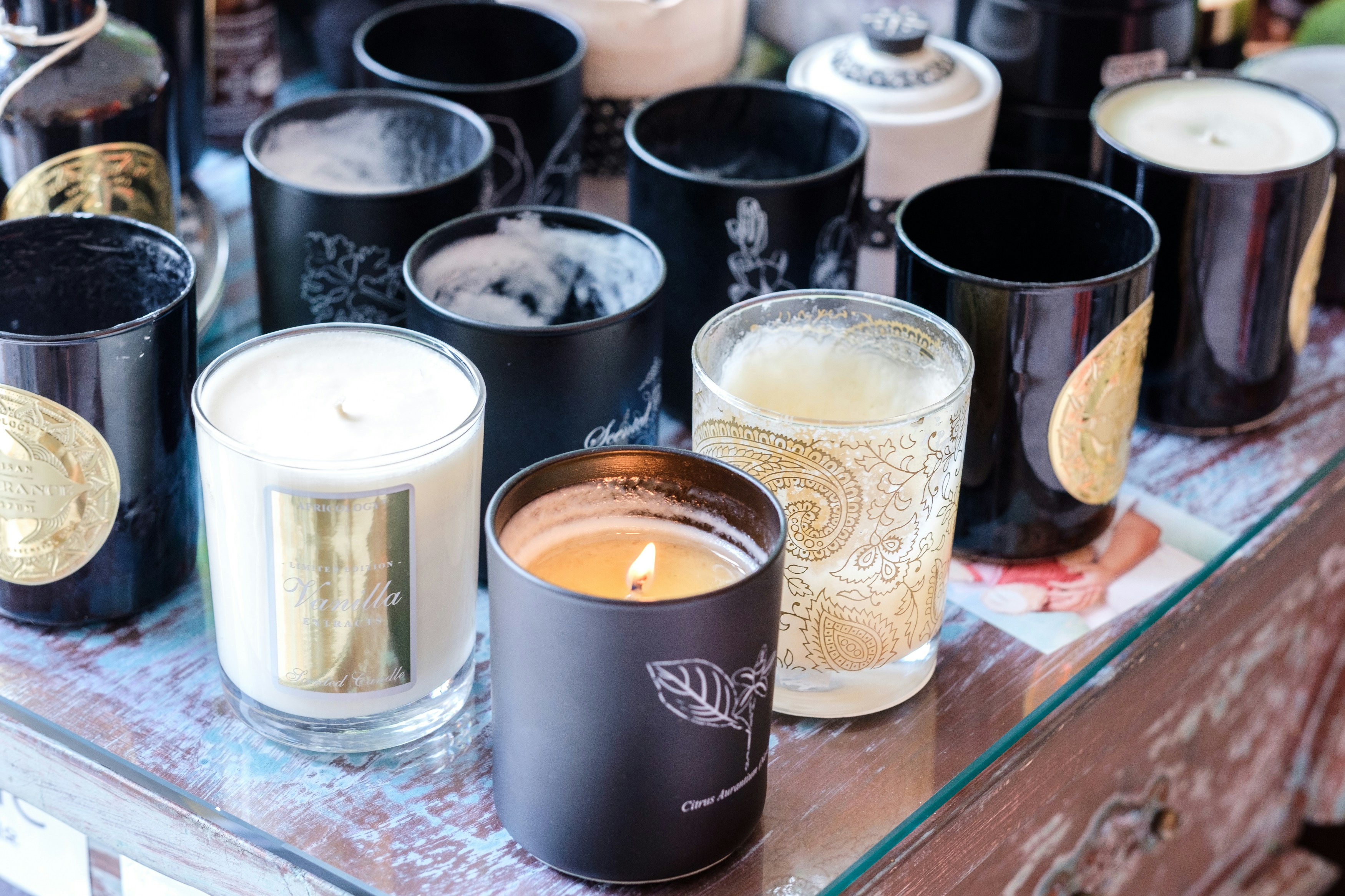 A table topped with lots of different types of candles photo – Free ...