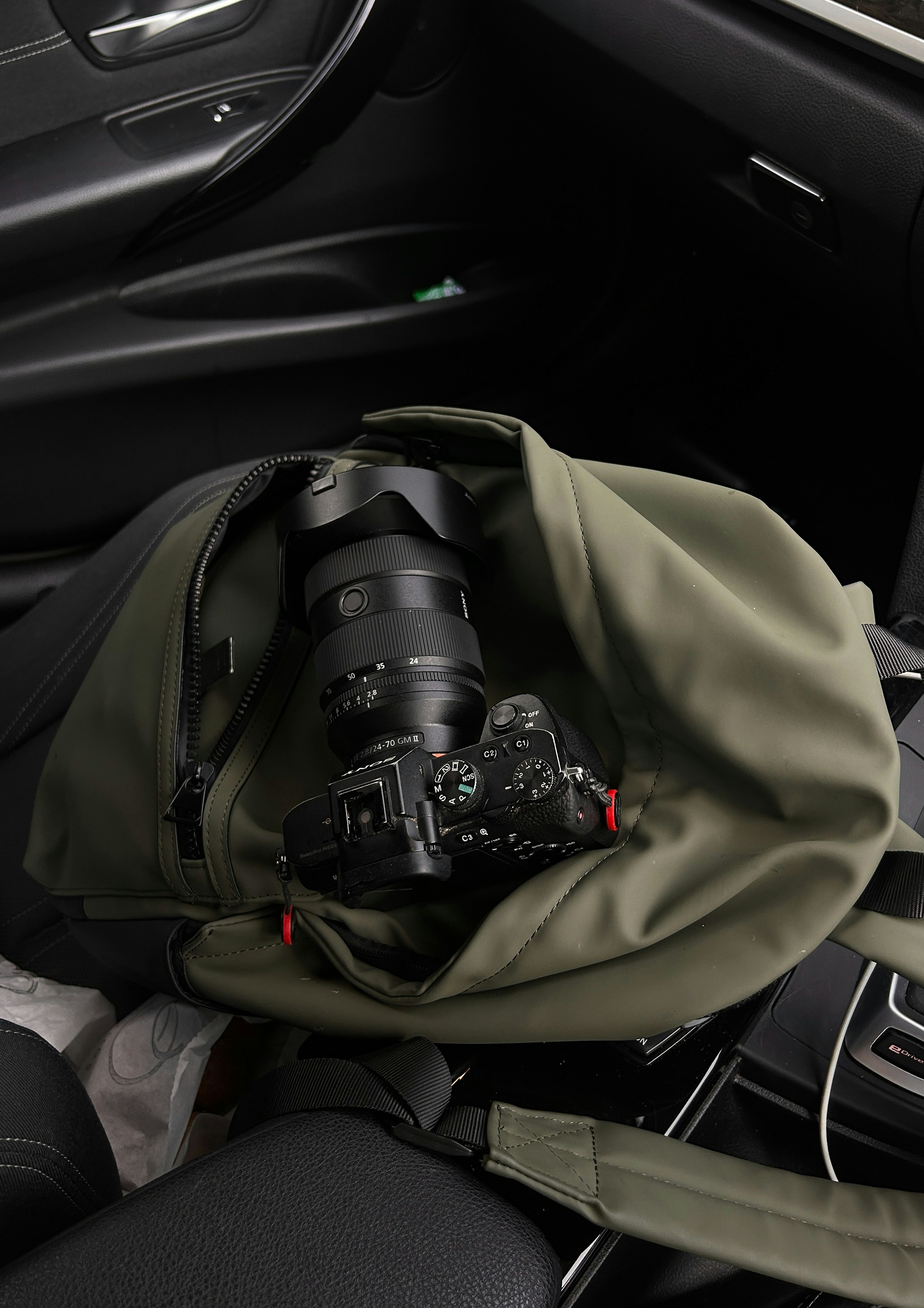 A camera bag sitting on the seat of a car photo – Free Bag Image on ...