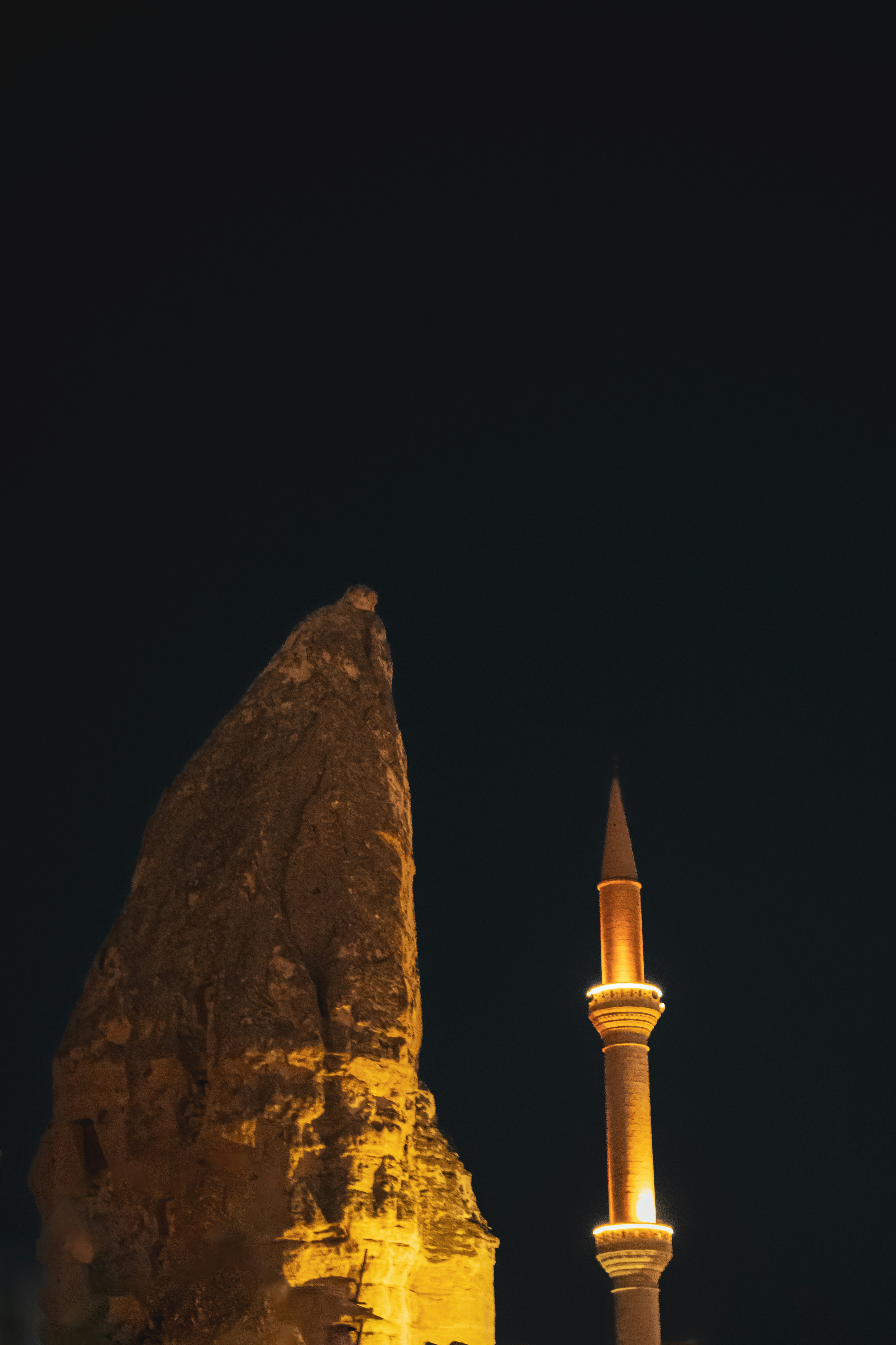 Moonlit Minaret beside a Weathered Sentinel