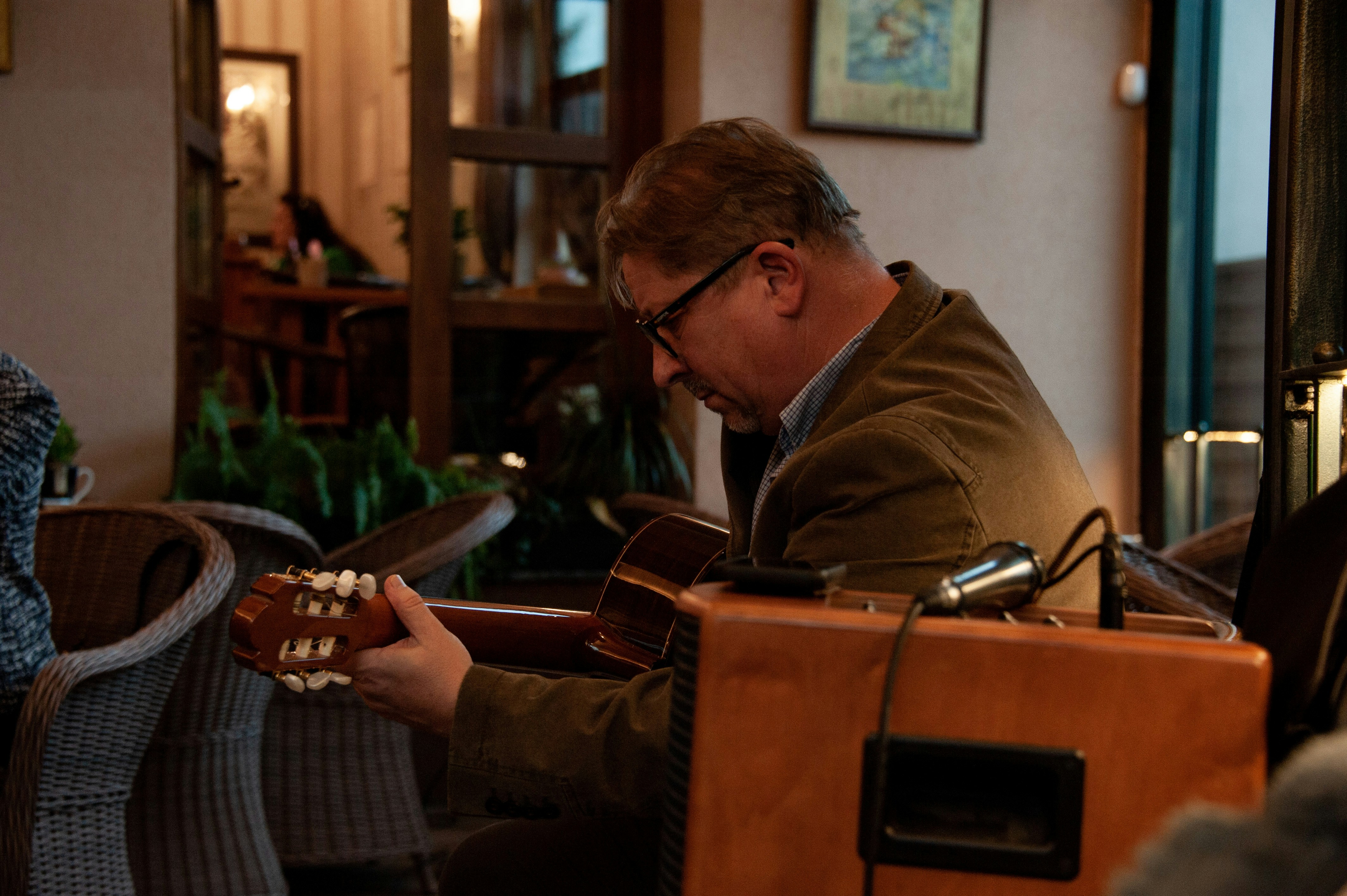 Café Serenade in Amber Light: A guitarist absorbed in his chords