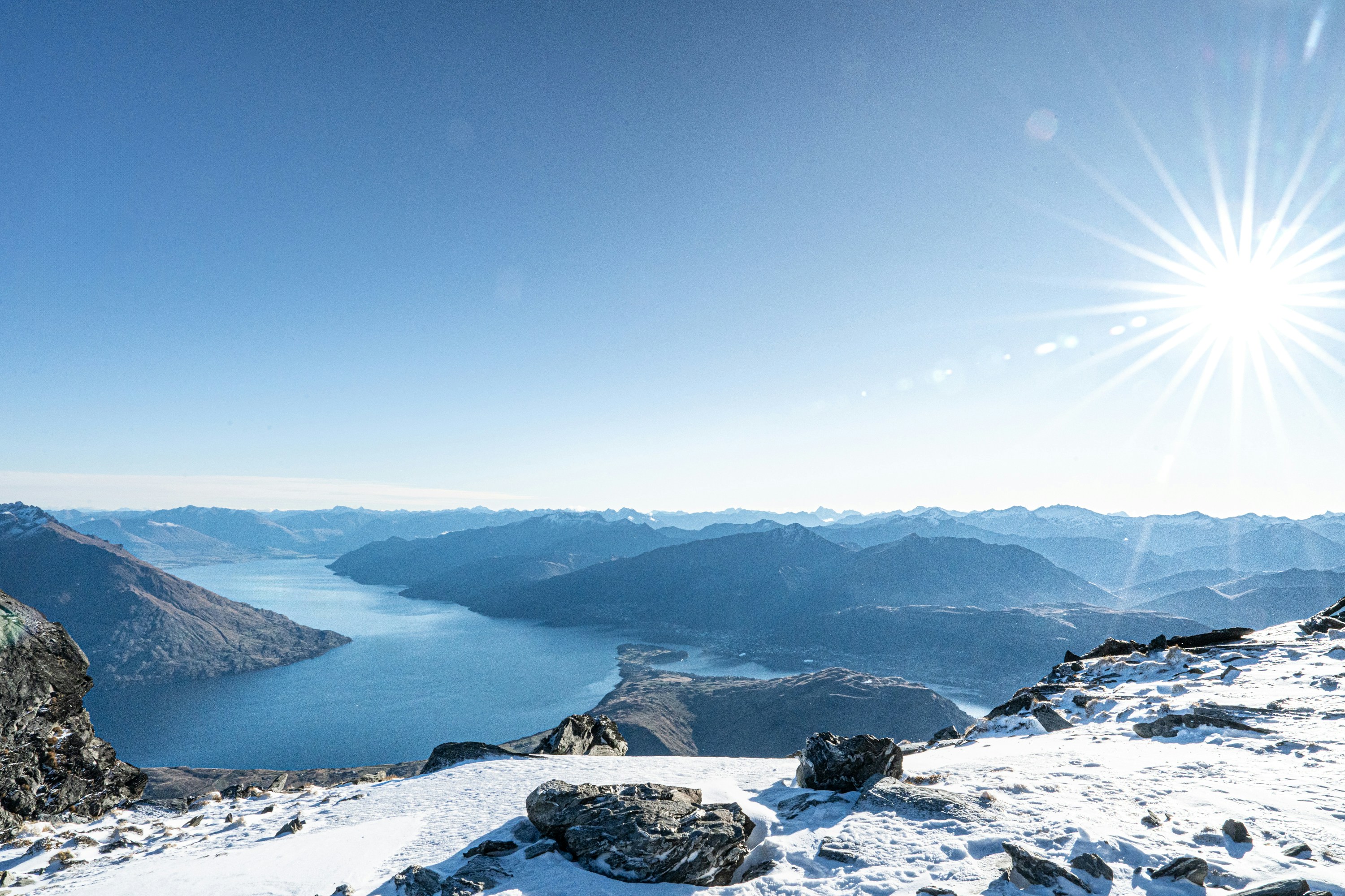 Sunburst Over a Snow-Capped Fjord: Ridgeview Above Blue Silence