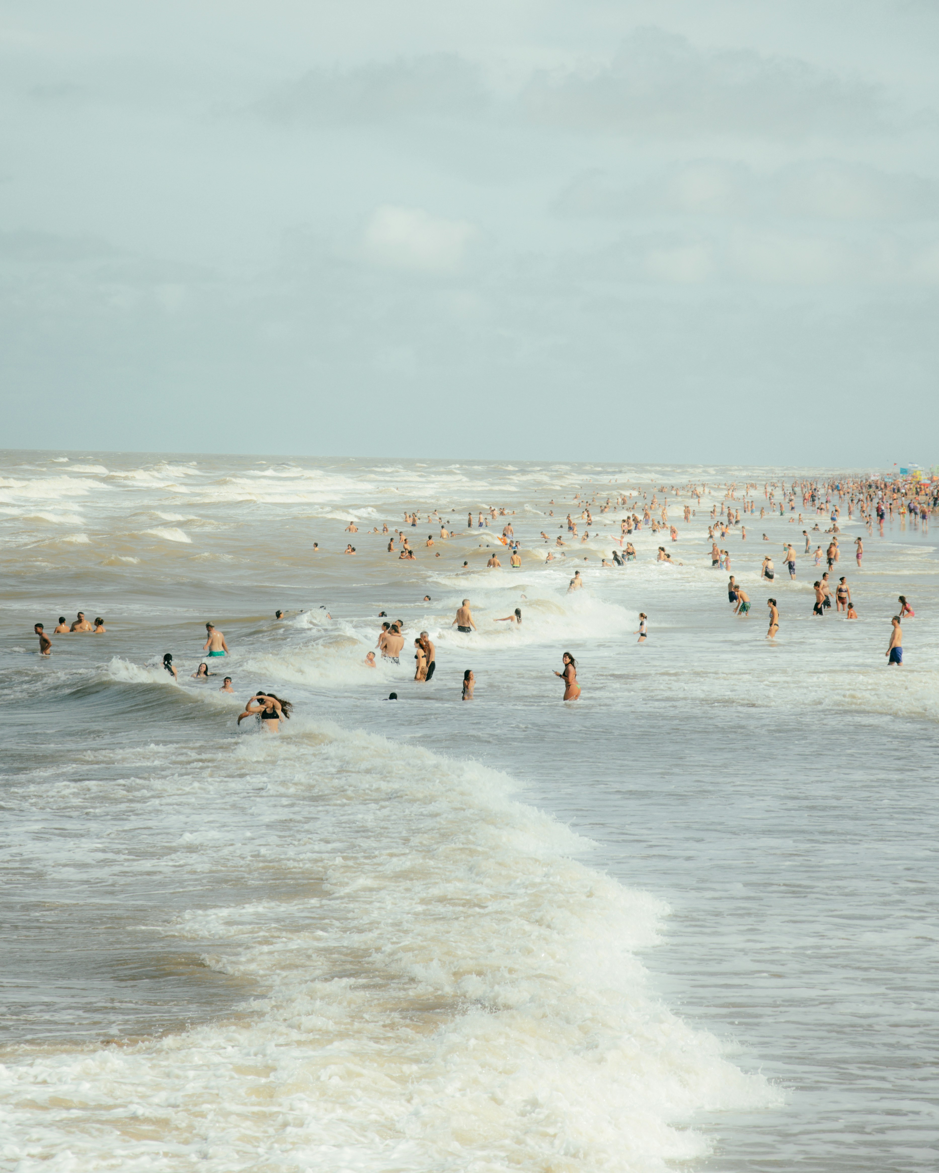 A large group of people swimming in the ocean photo – Free Beach Image ...