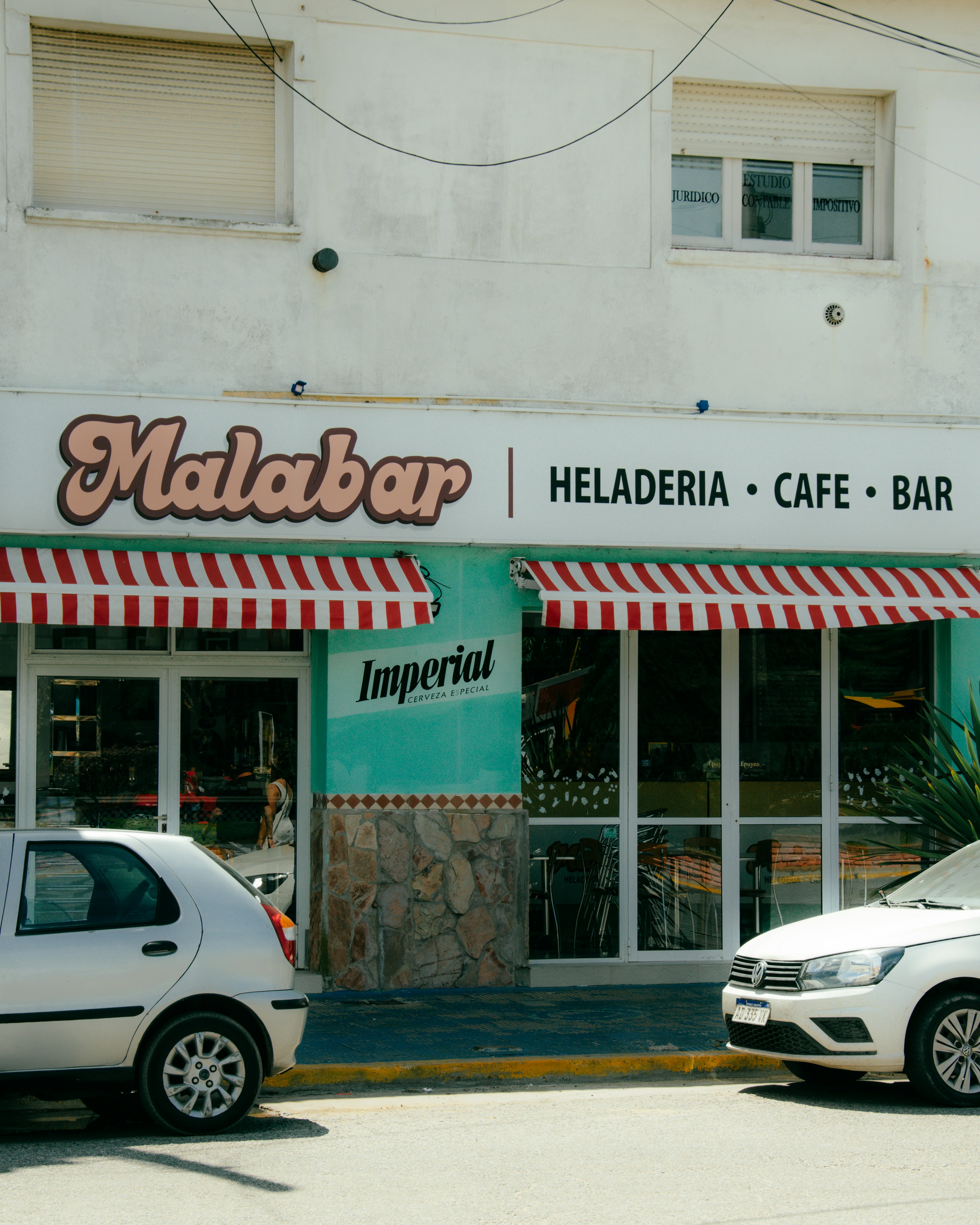 Malabar Café Front: Striped Awnings, Signage, and Street Life